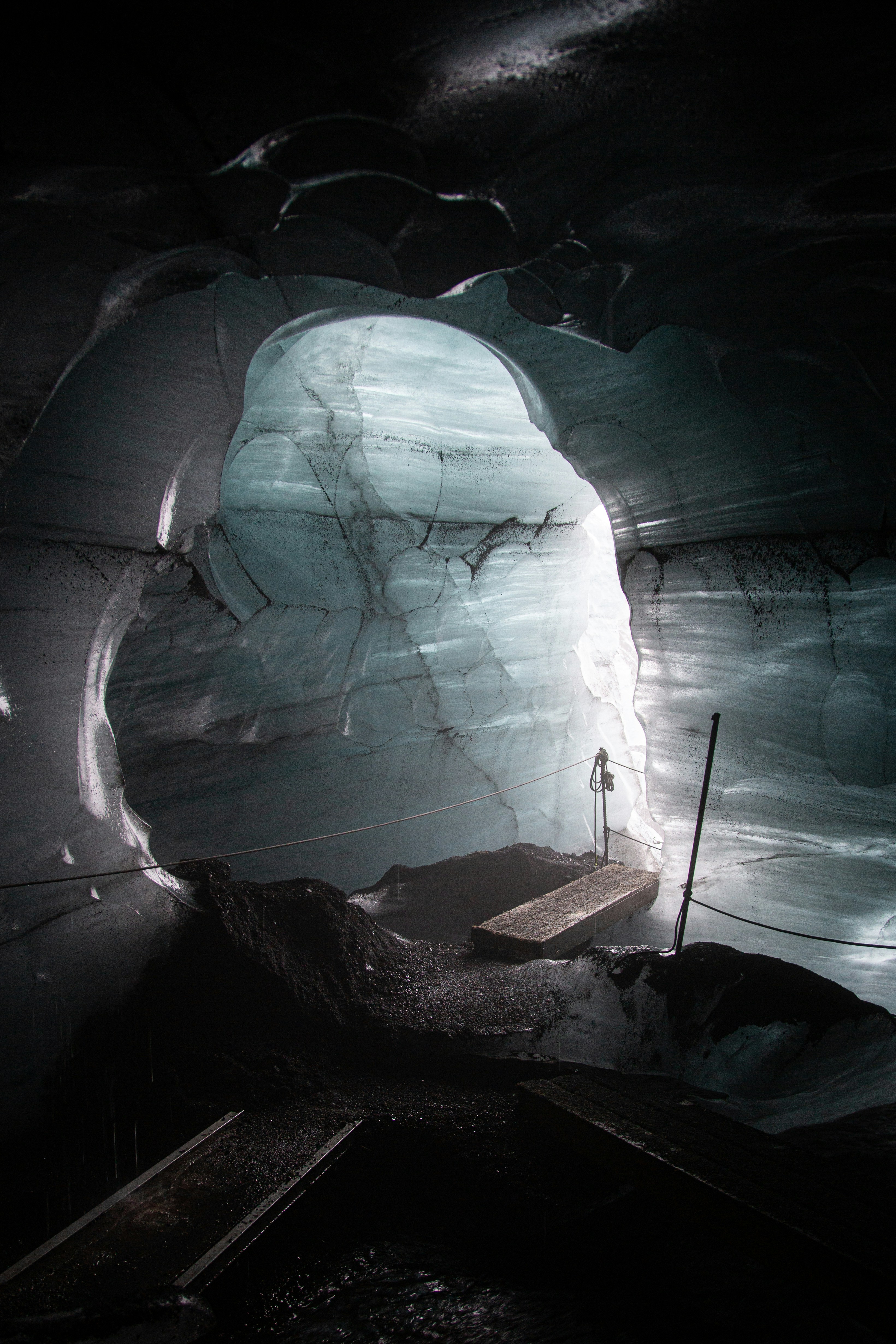 Glacial Portal: Ice Cave Entry Bathed in Frigid Light