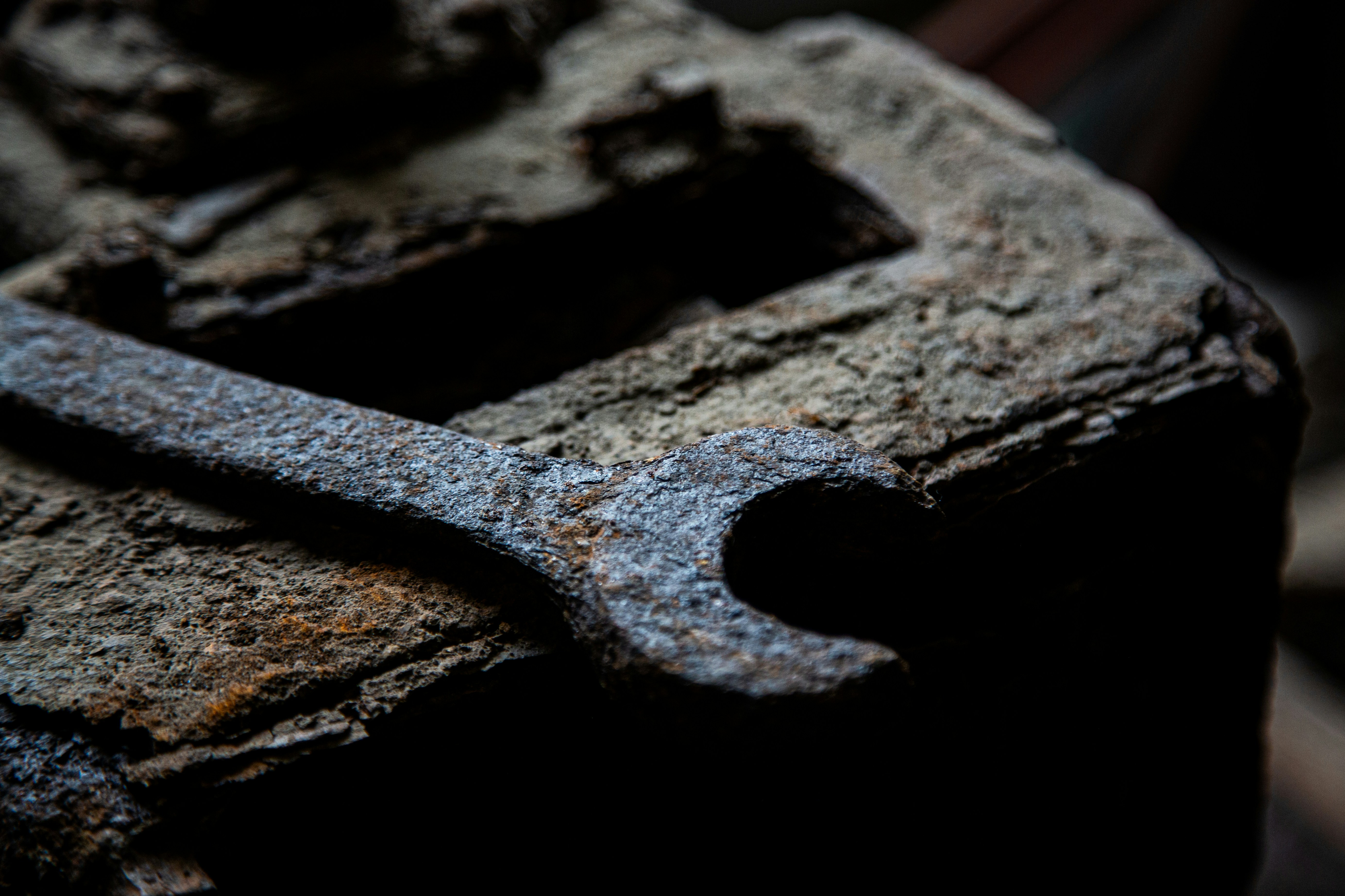 Rustic Iron: A Weathered Hook Against Timeworn Brick