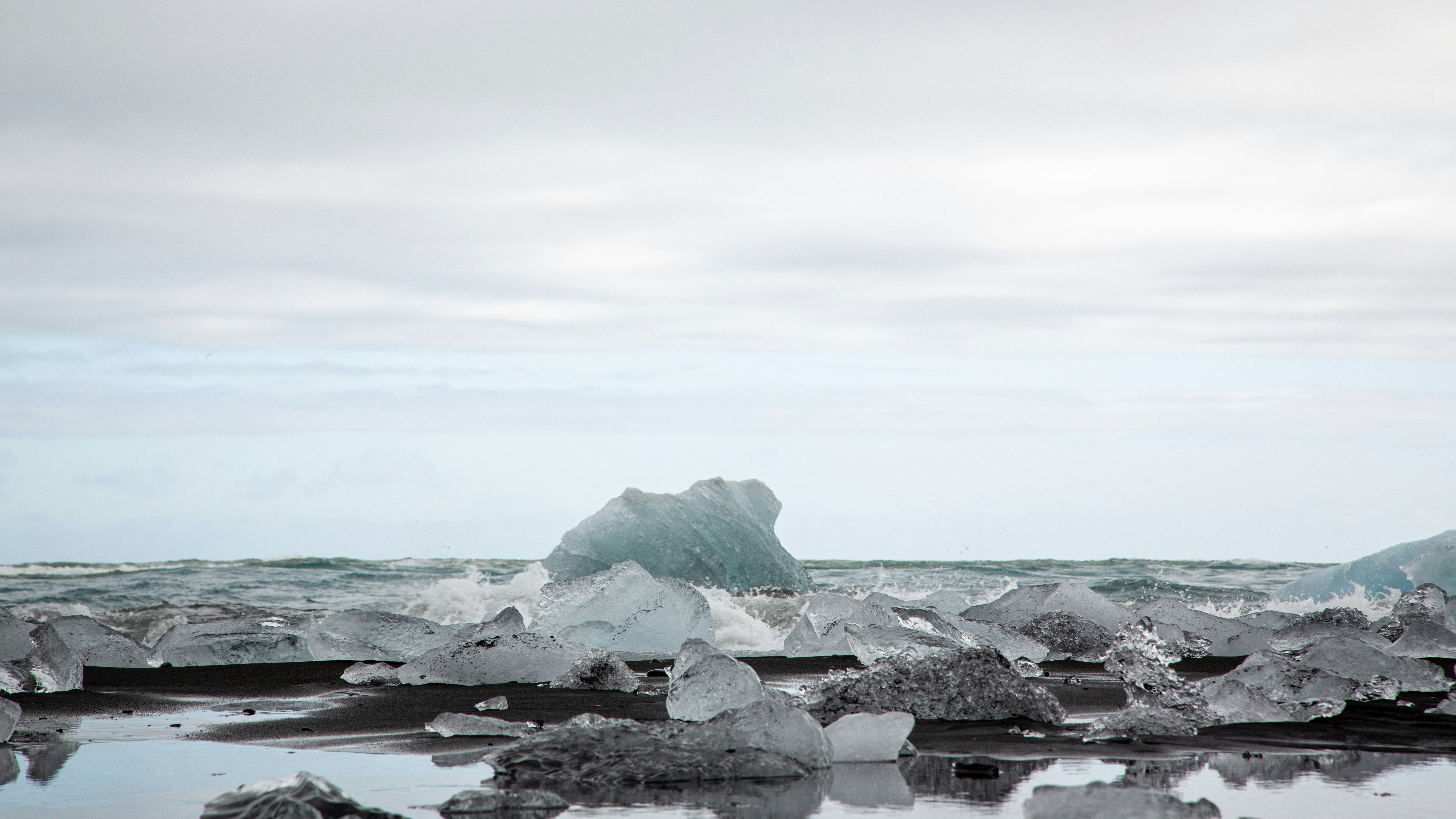 Icebound Horizon: Icebergs Resting Along a Quiet Shore