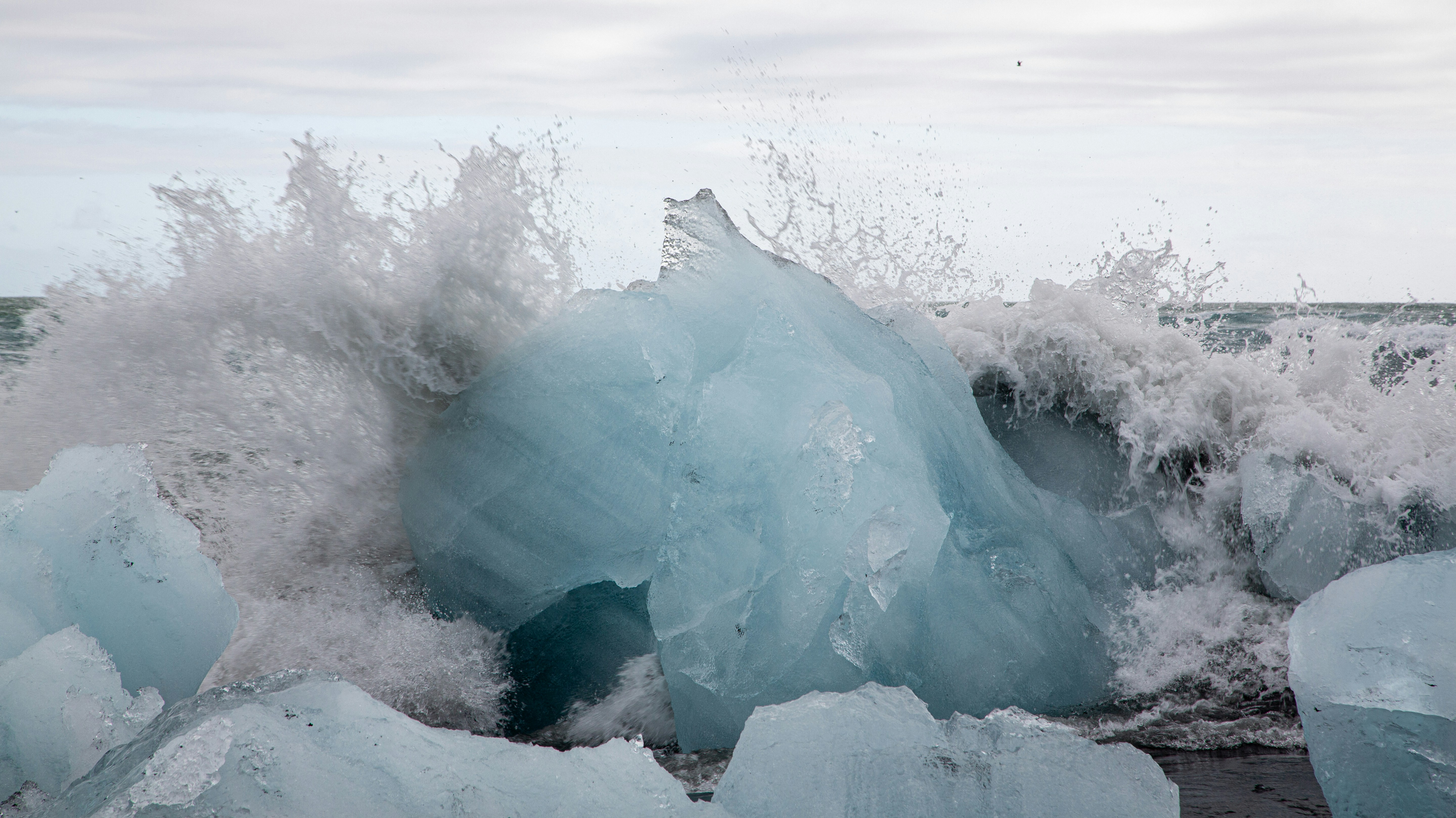 Icebound Breakers: Blue Glacial Fragments Carved by Ocean Surge