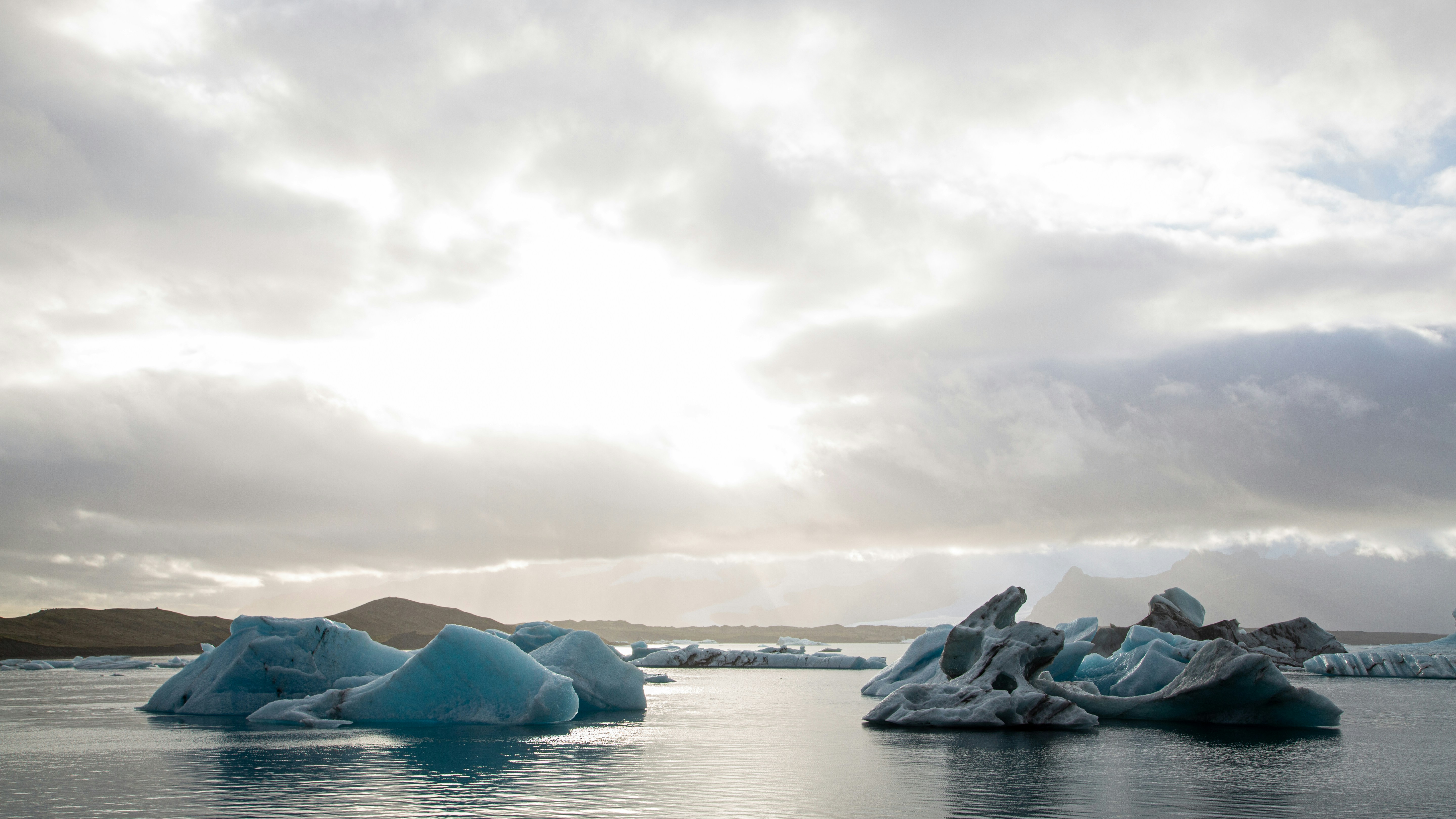 Glacial Quiet: Icebergs Rest Under a Larmed Sky