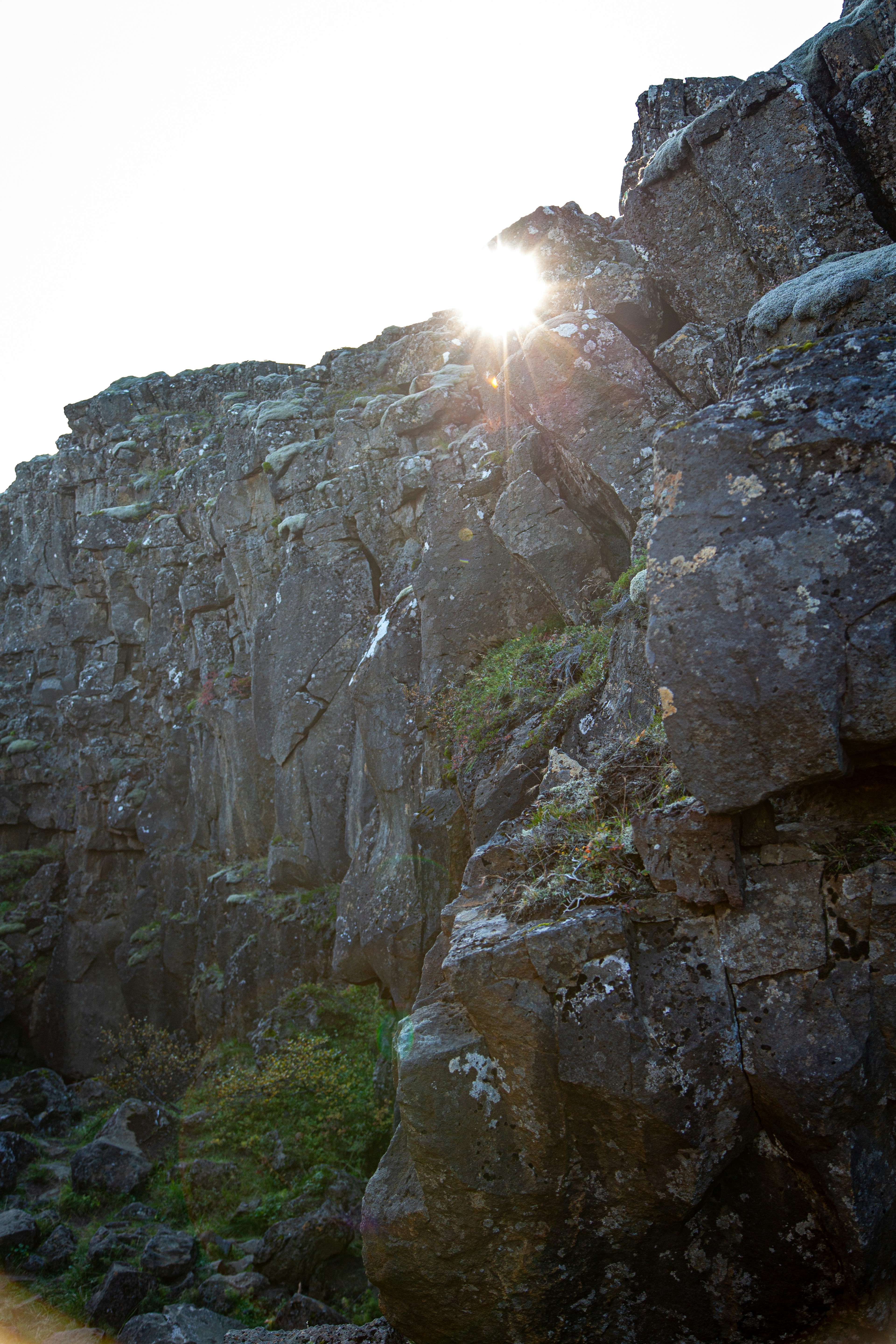 Sunburst Over Rugged Cliff: Morning Light on Jagged Basalt