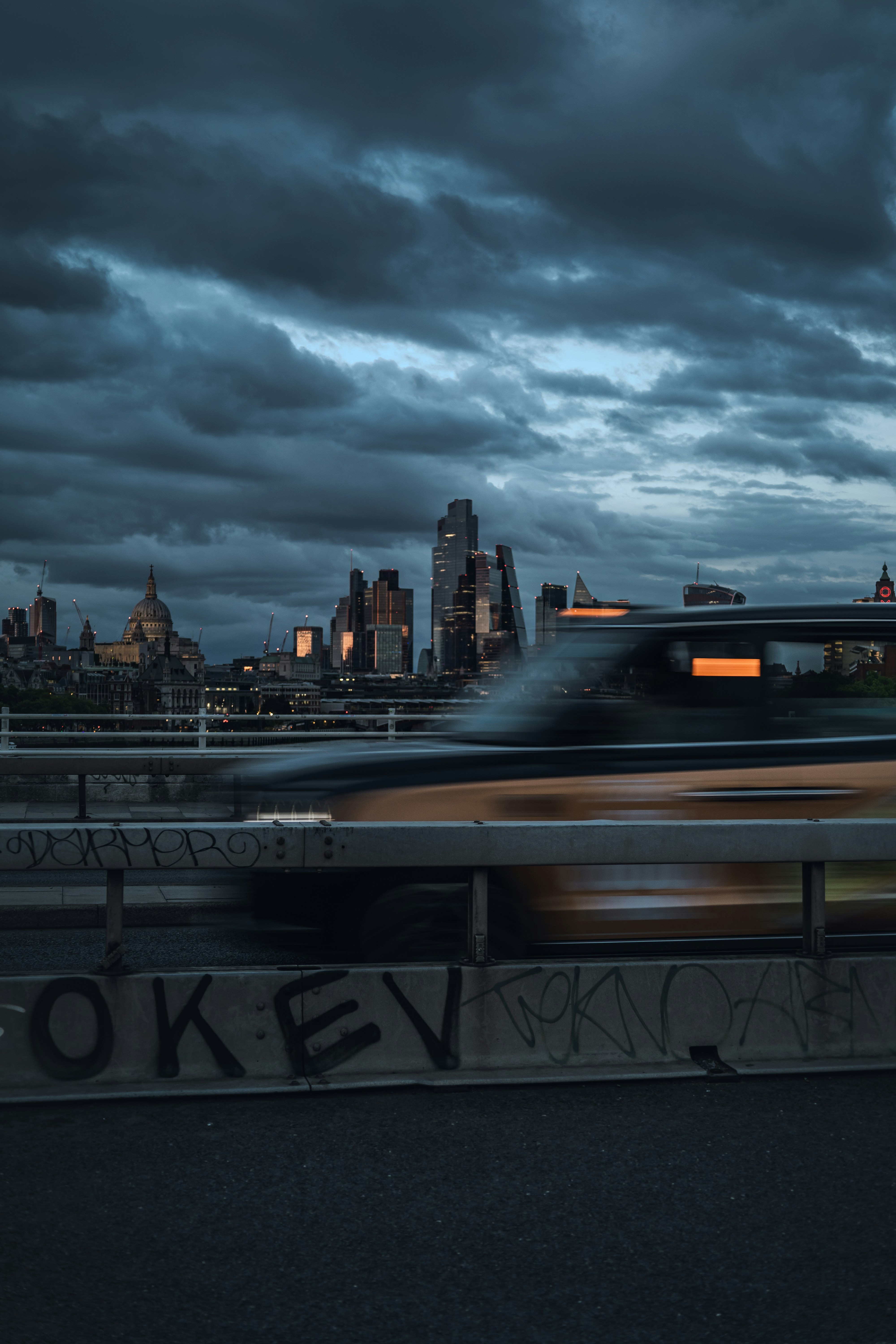 City in Motion: Blurred Bus on London Bridge at Dusk
