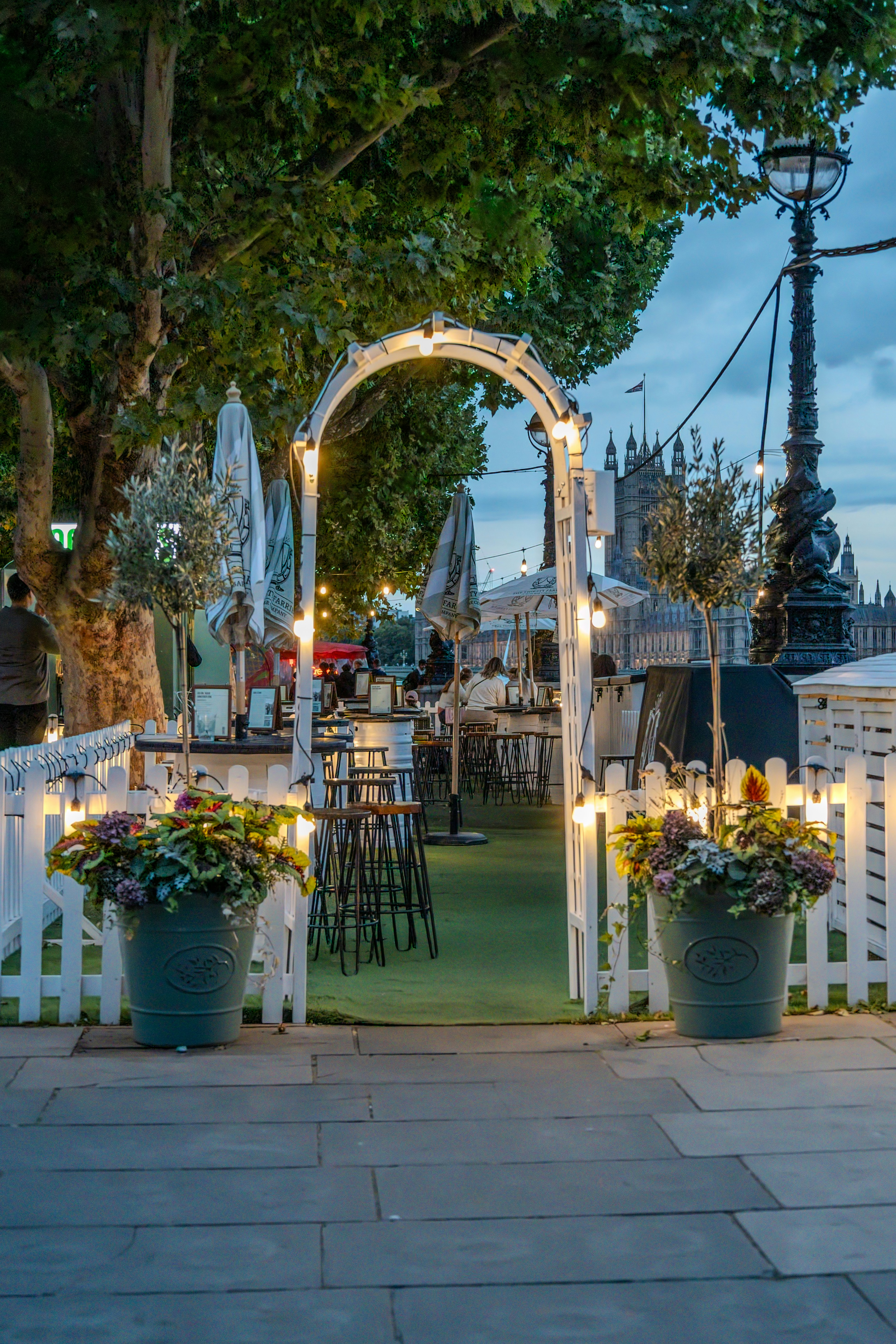 Archway to Evening Alfresco: Lantern-lit Terrace by the River Thames