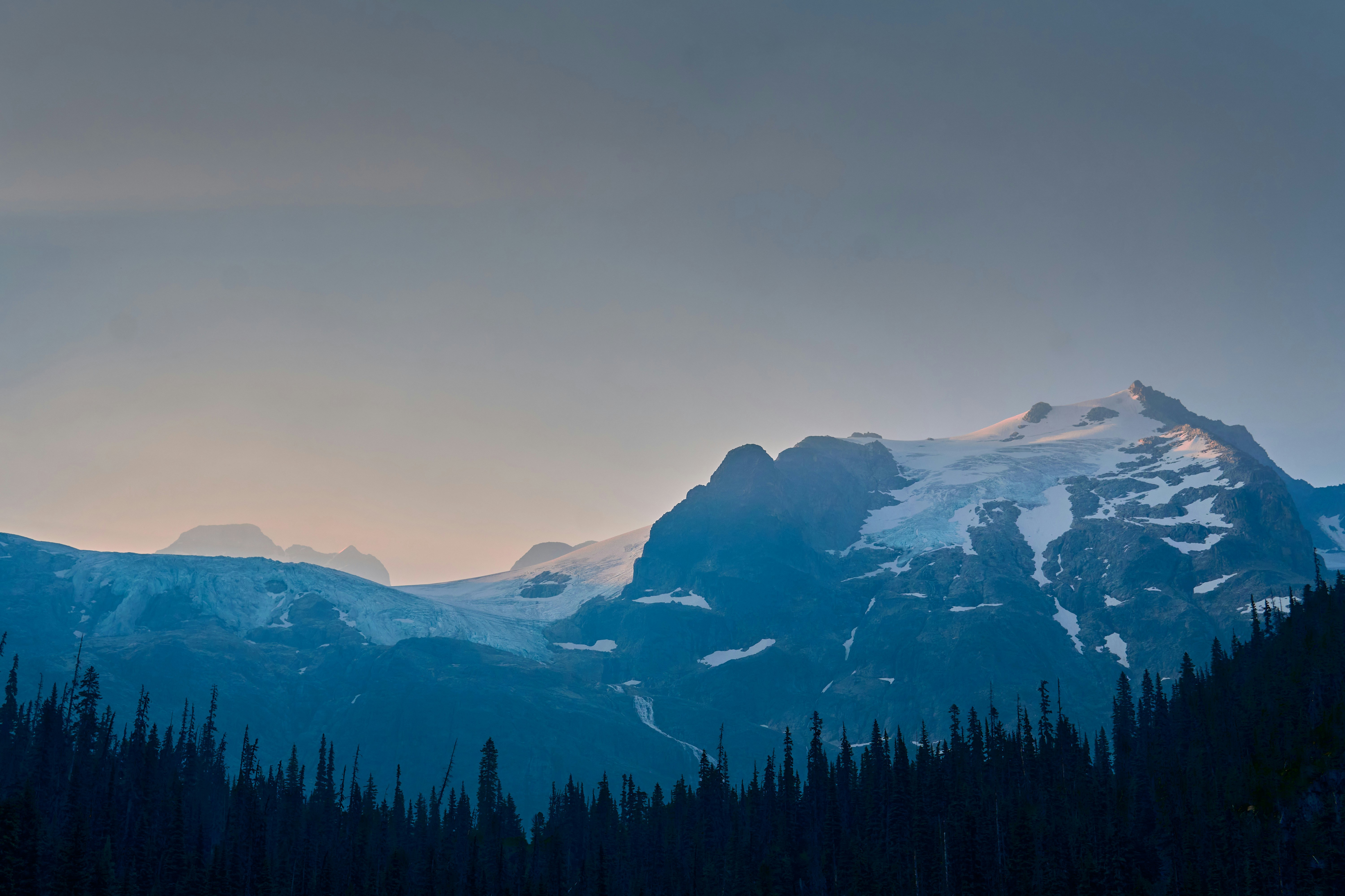 Twilight Peaks: Snowlit Summit Under a Dusky Sky