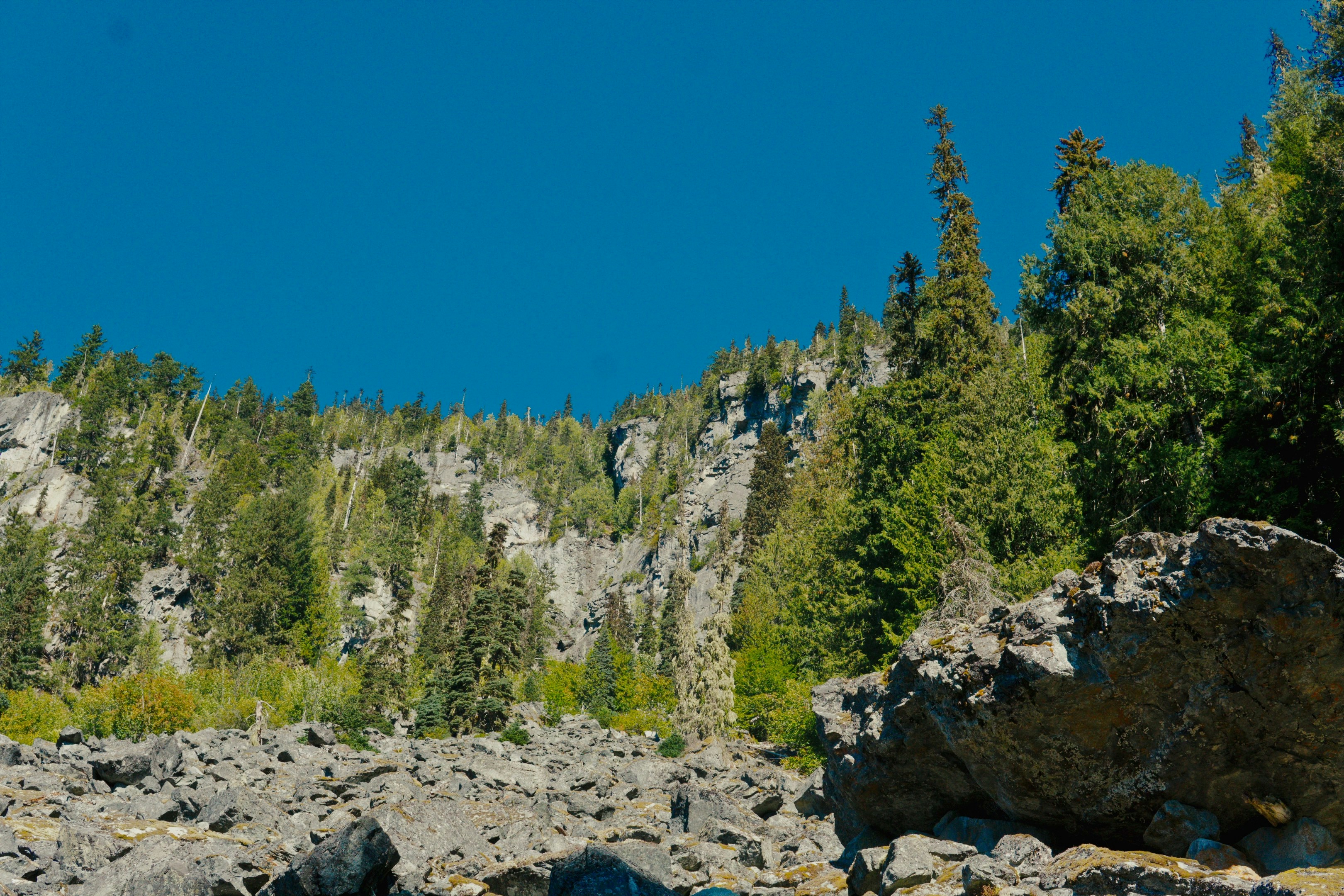 Rugged rocky shoreline beneath a cerulean sky