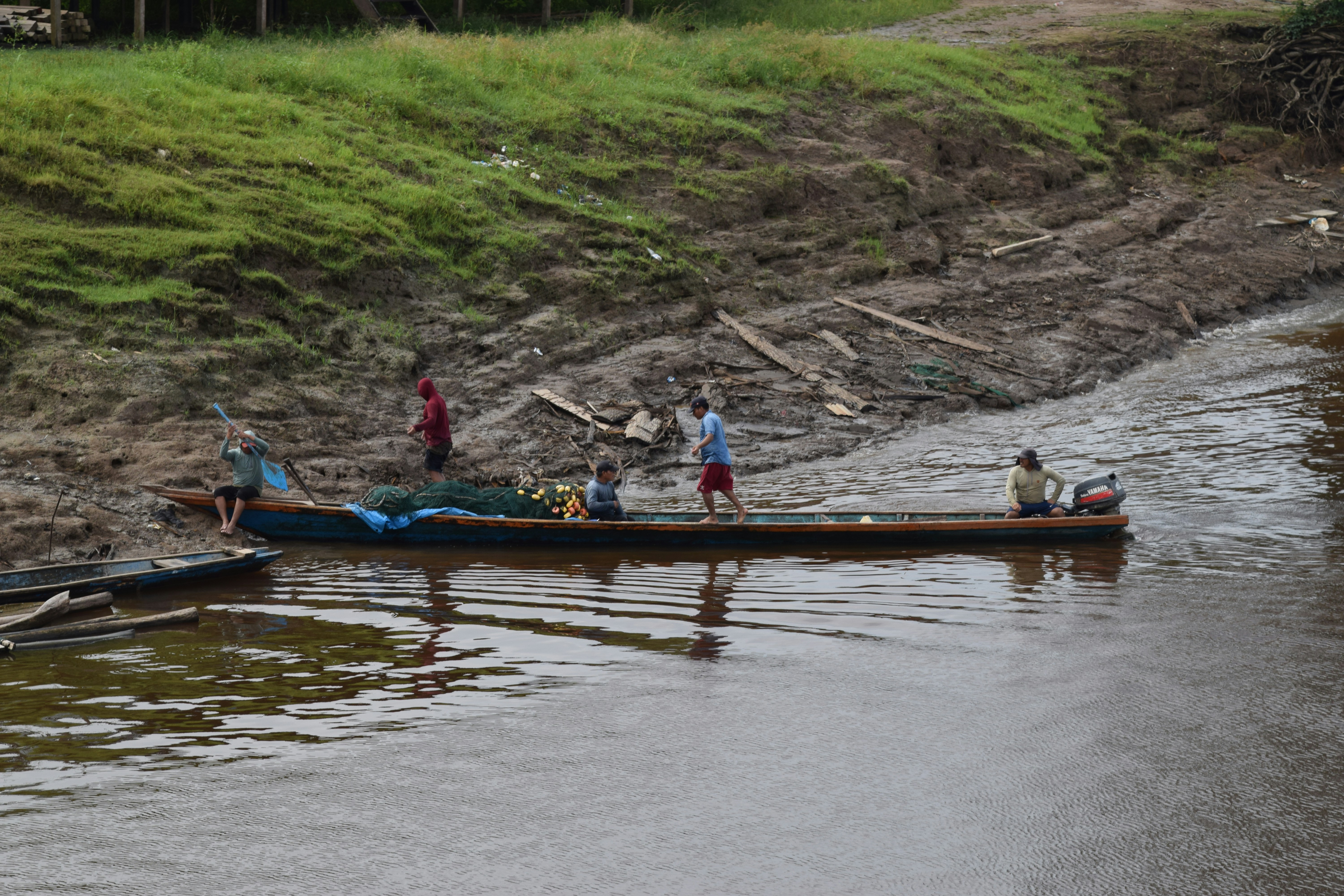 Longboat Crossing: a row of figures along a muddy riverbank