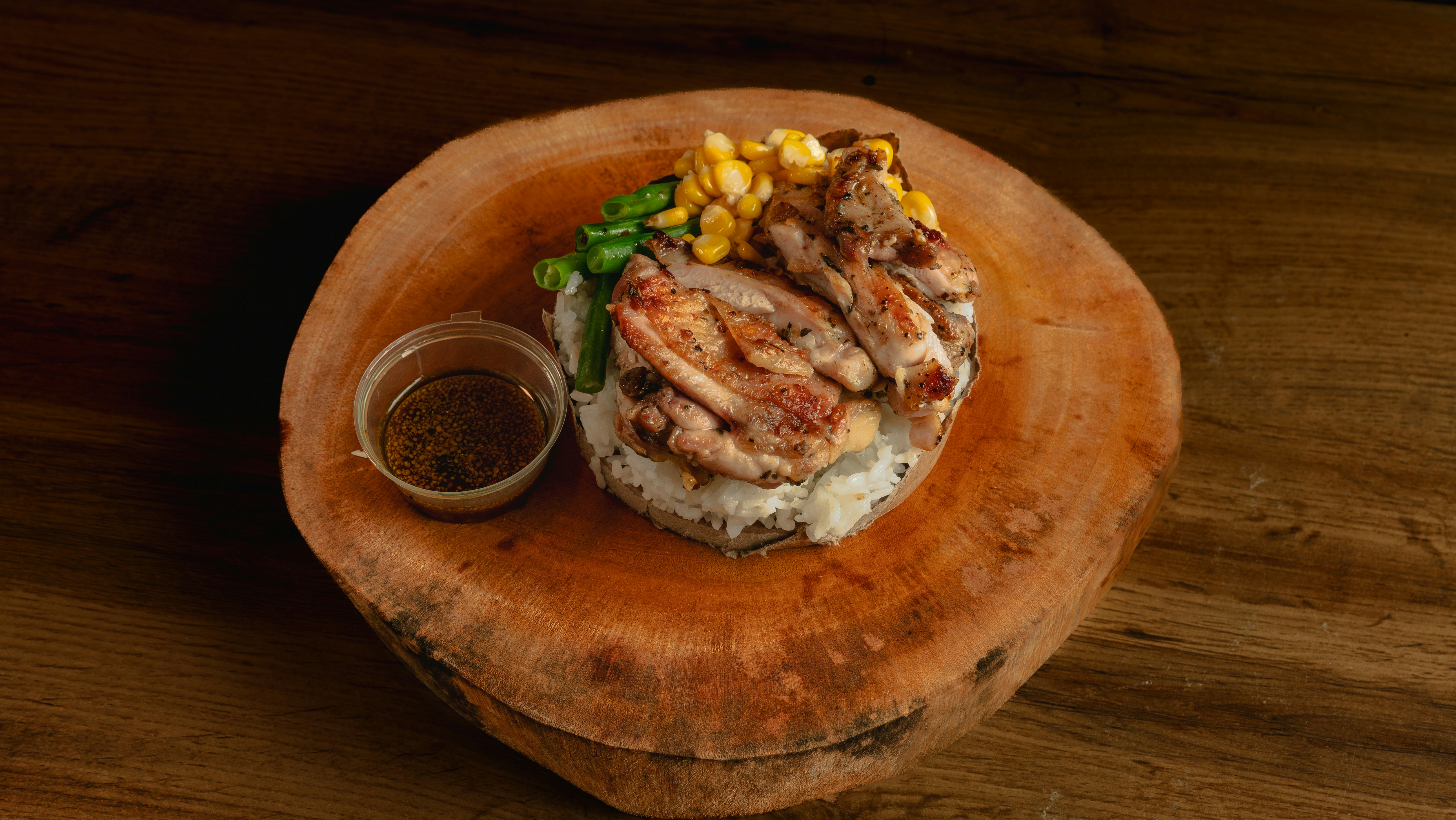 Charred Poultry on a Rustic Banana Slice with Corn Garnish