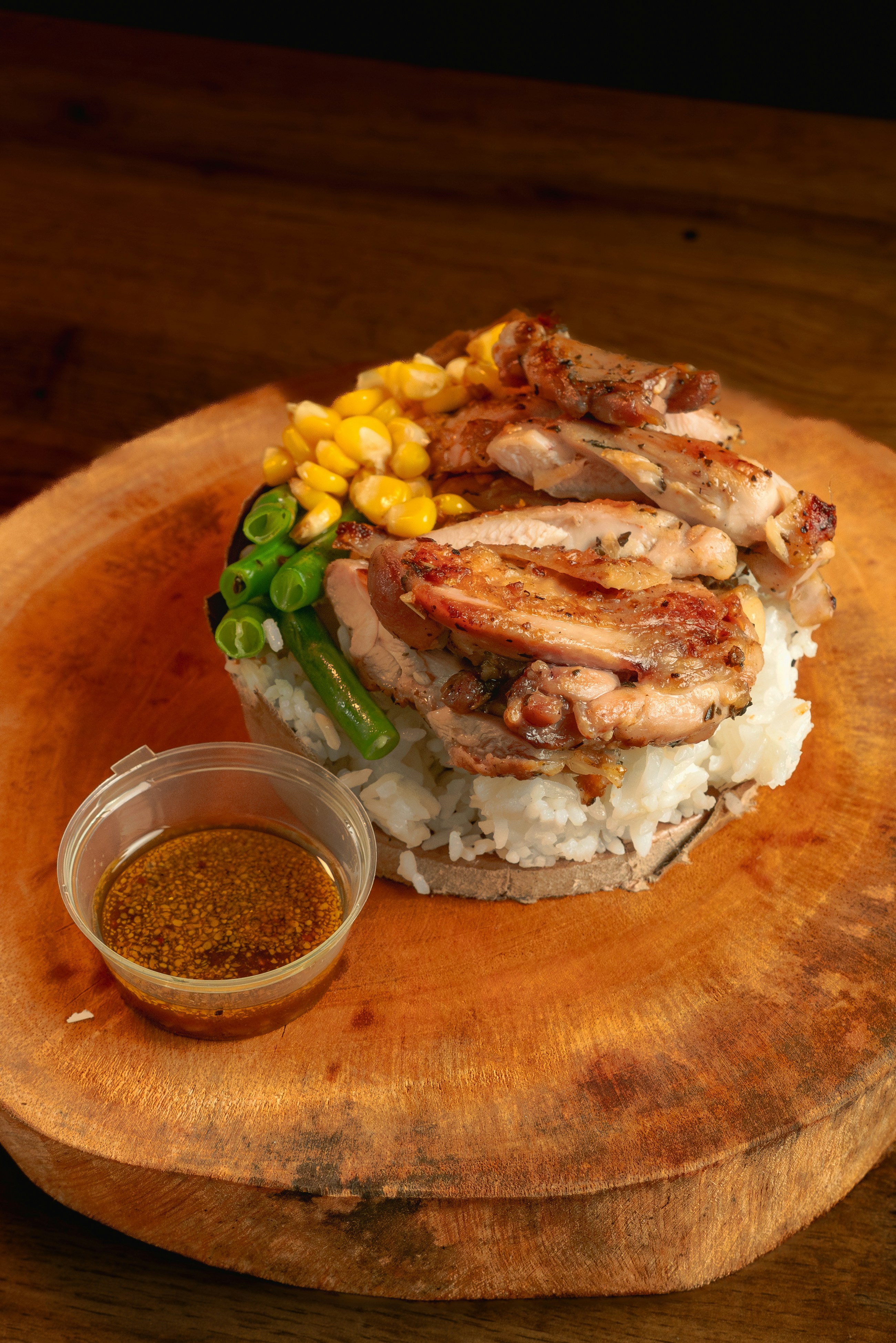 Charred Topped Rice Stack on a Rustic Wooden Platter