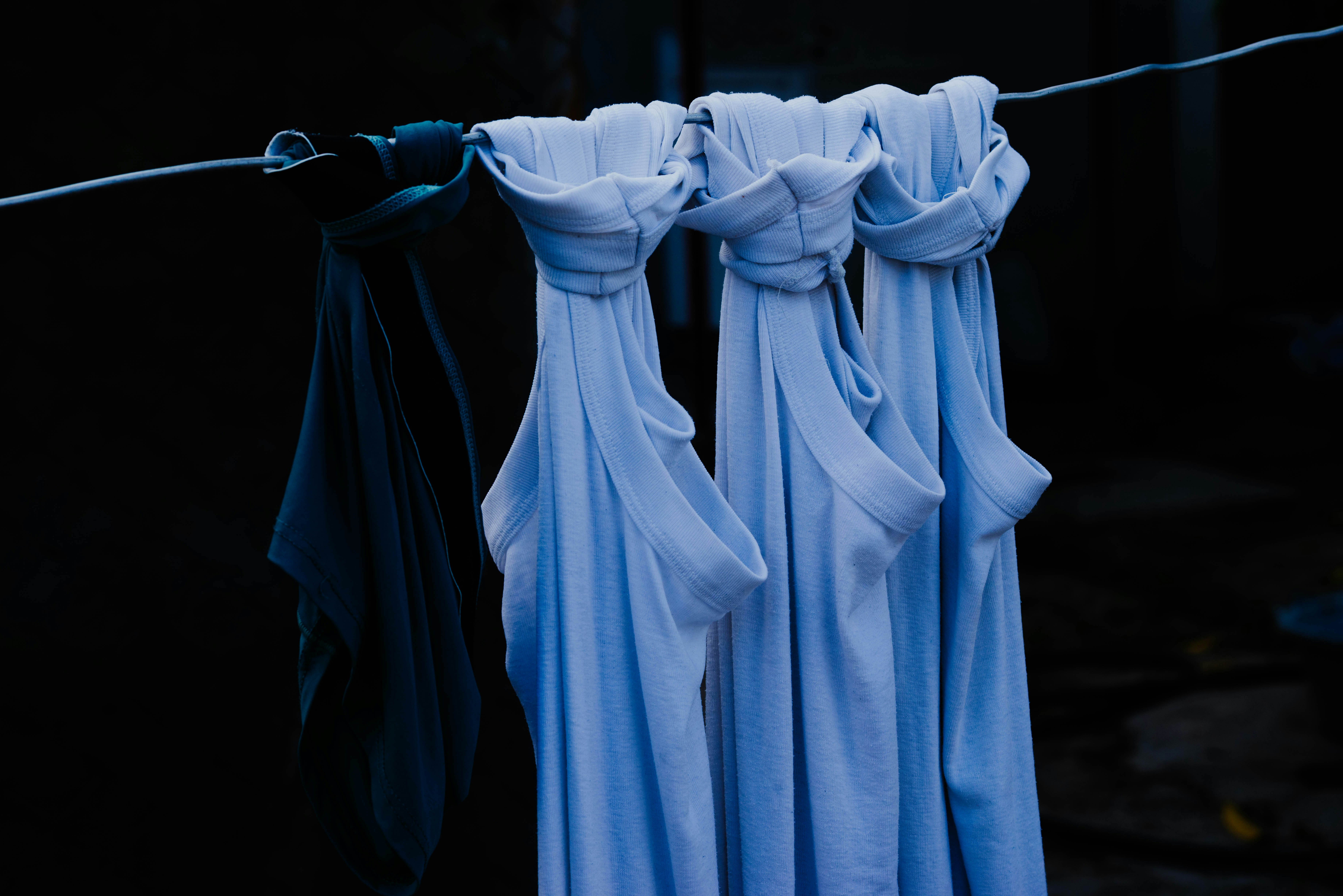 Blue garments on a clothesline: quiet atmospheric dusk