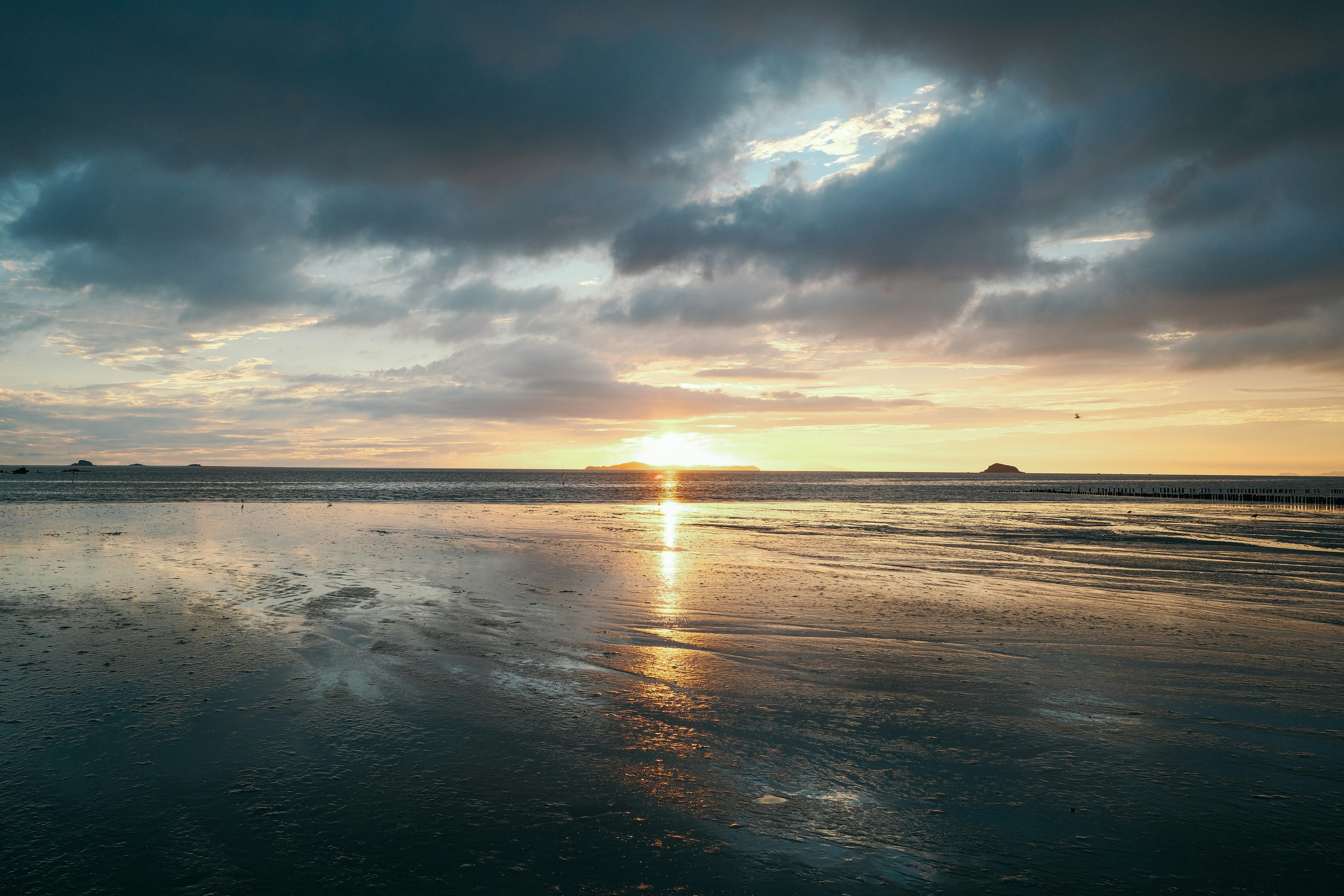 Dawn on the Wet Horizon: Sunset Mirror on Tidal Shore
