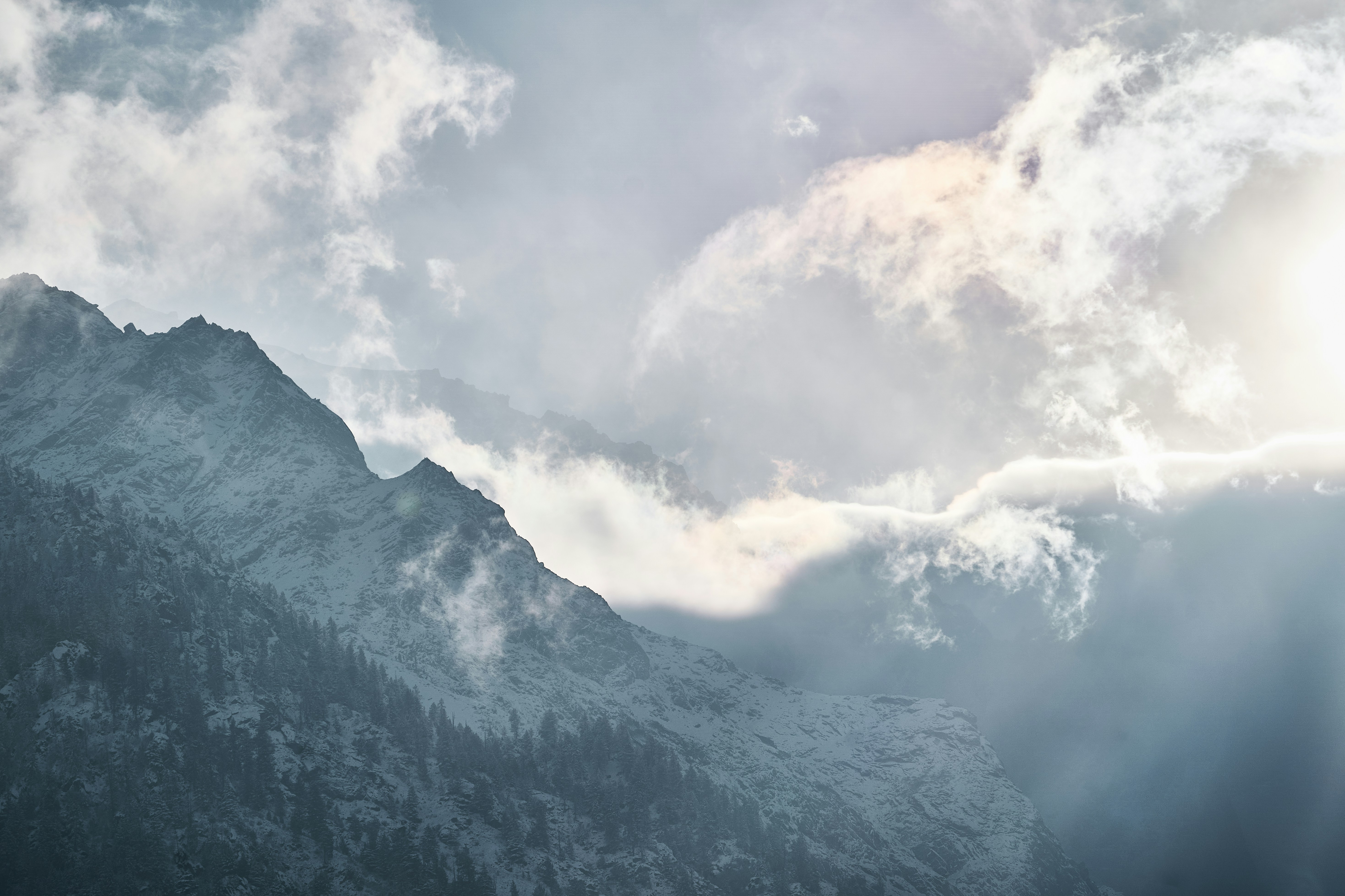 Sunlit Ridge Beneath Sweeping Clouds
