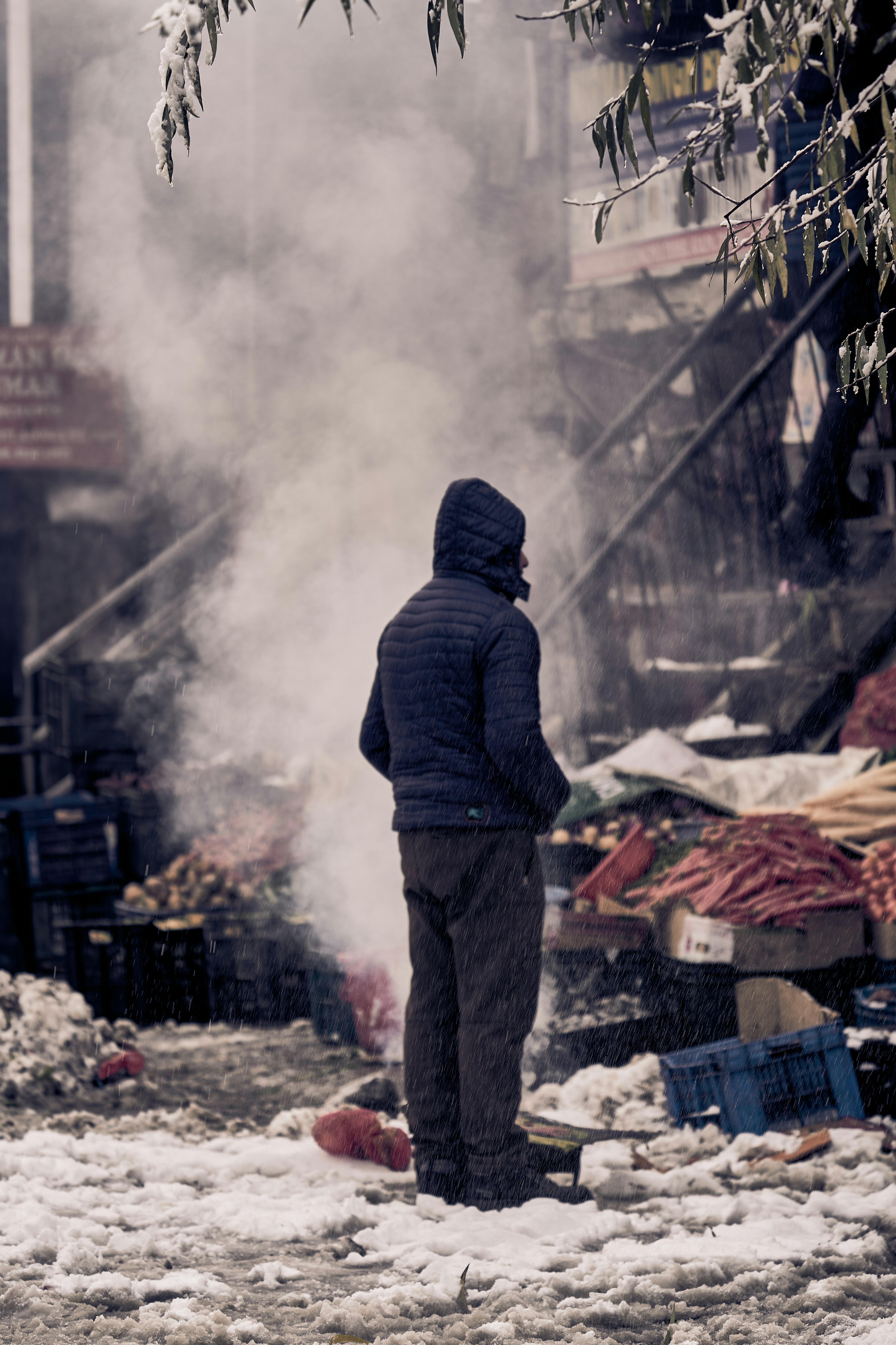 Cold Quiet Amid Smoke: A Street Vendor Stands Ground