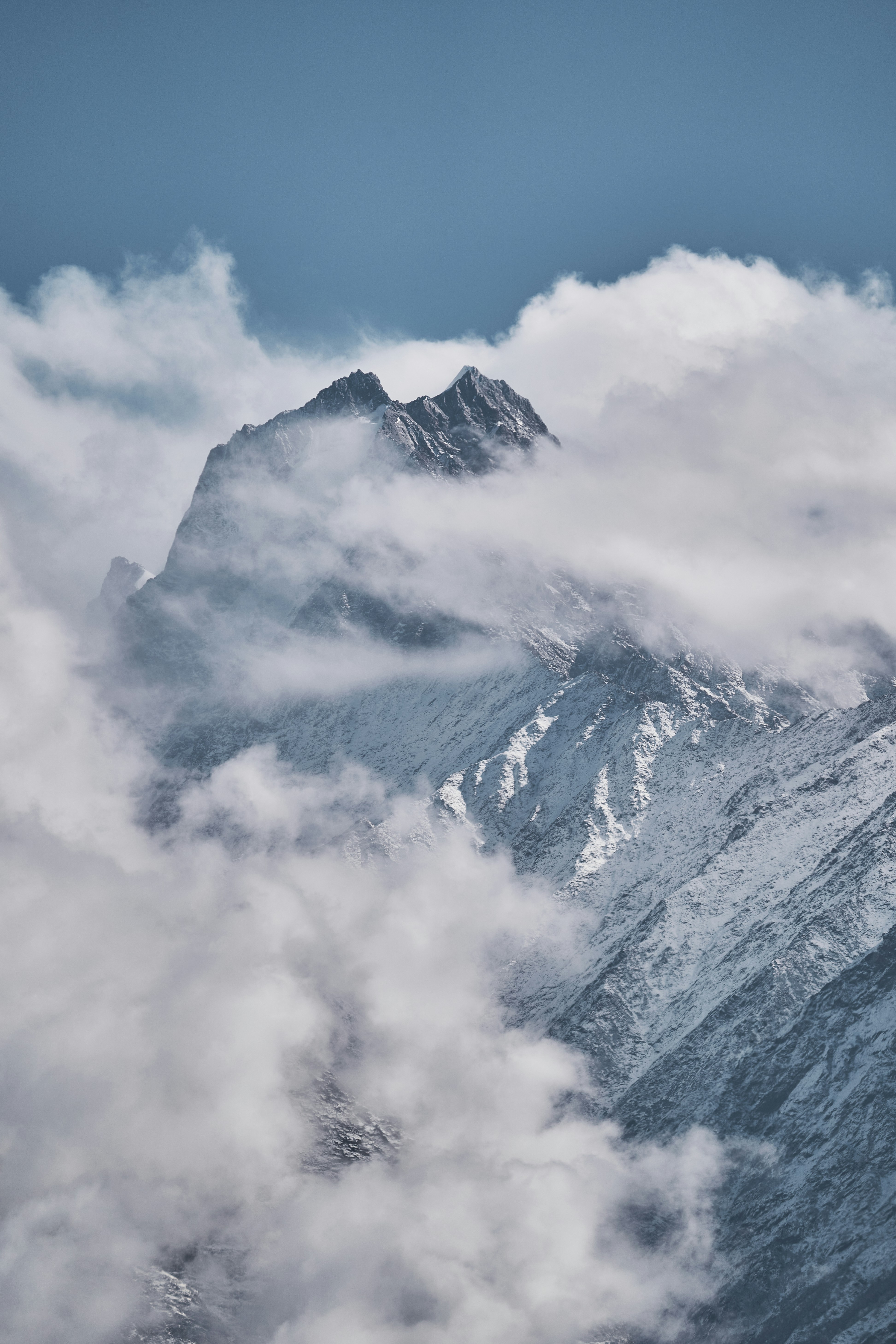 Summit Pierced by Clouds: A Mountain Crowned in Mist