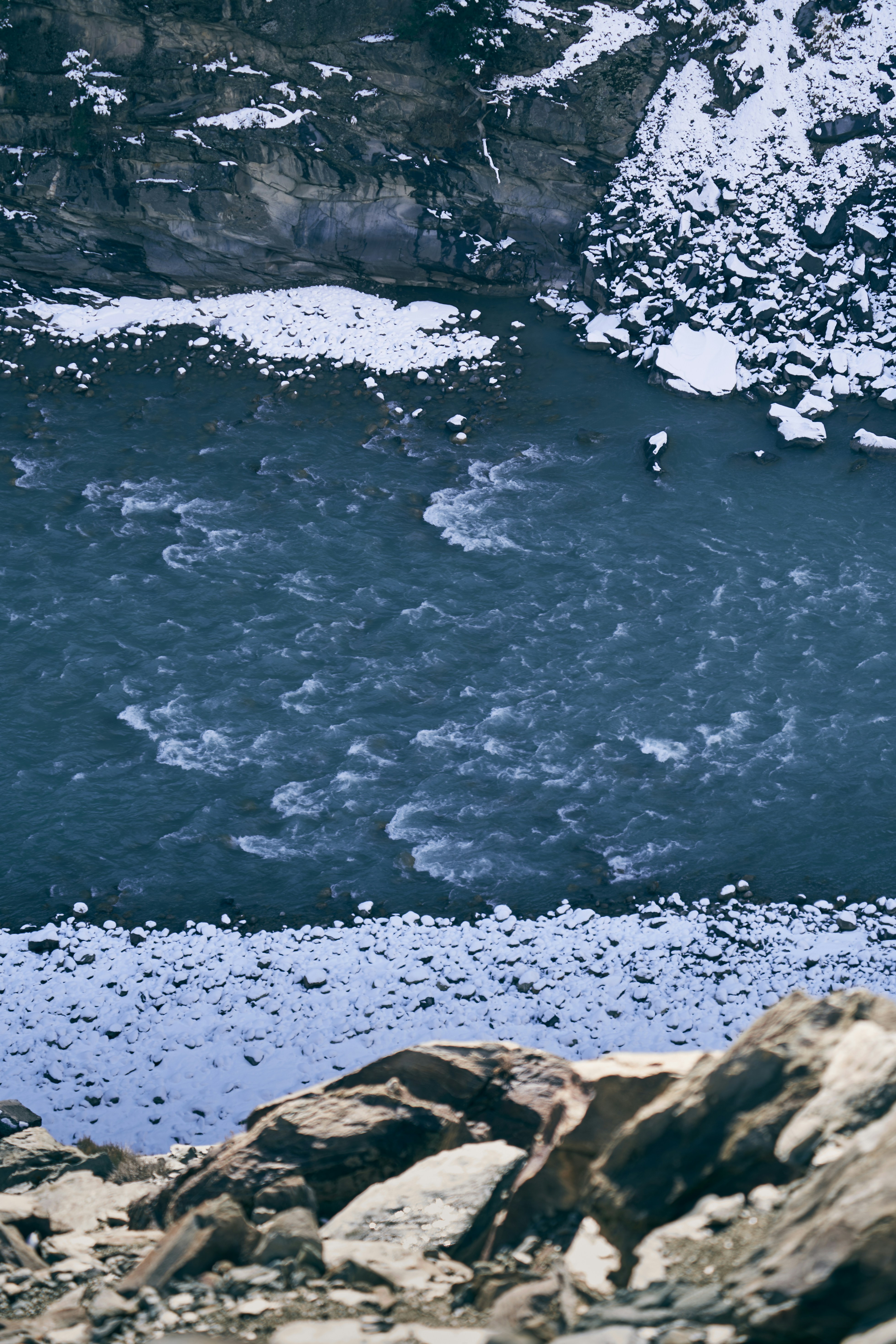 Icy Cloak Over Turquoise Waters at the Mountain Shore