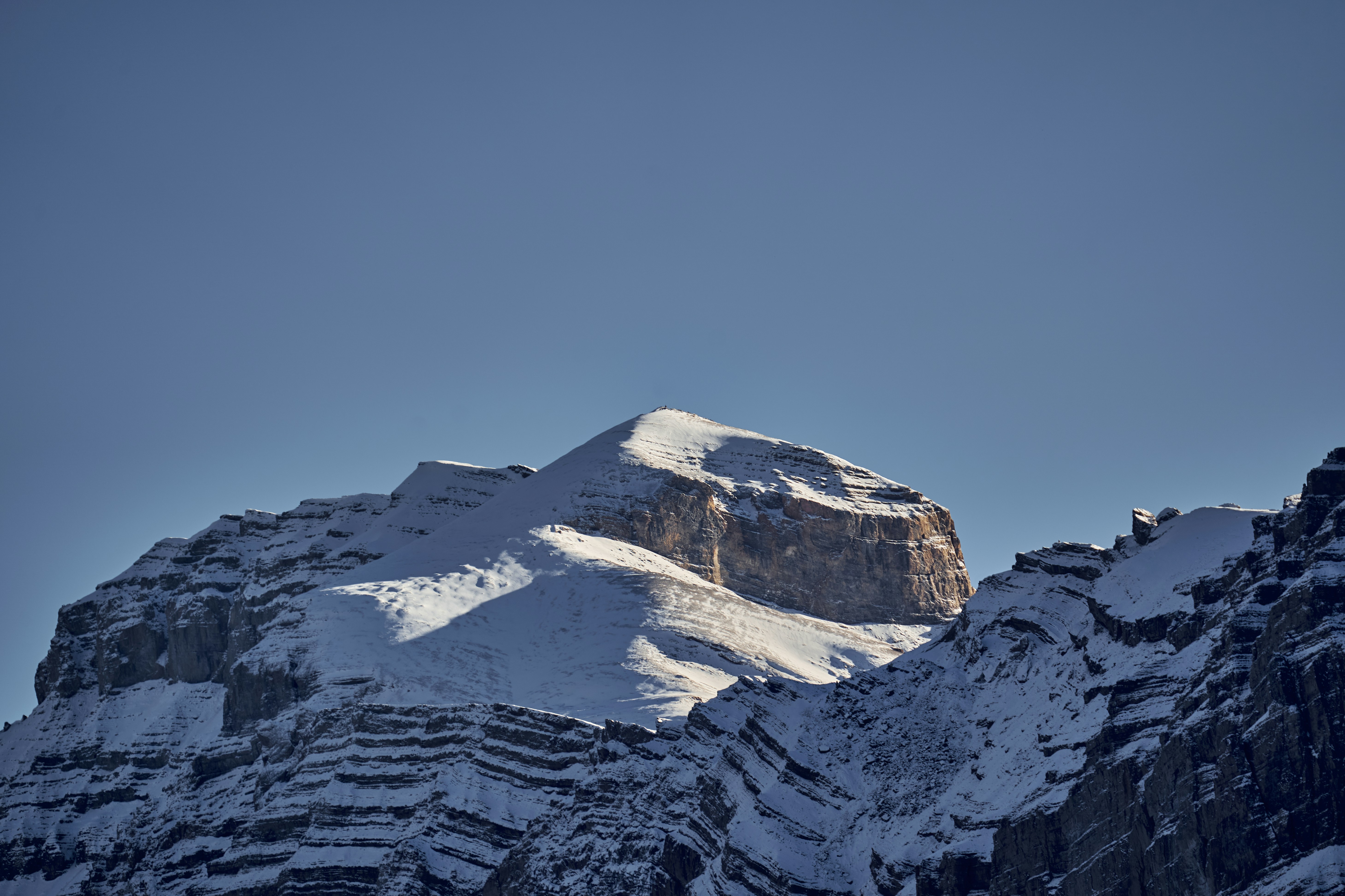 Snow-Capped Summit Under a Clear Violet Sky