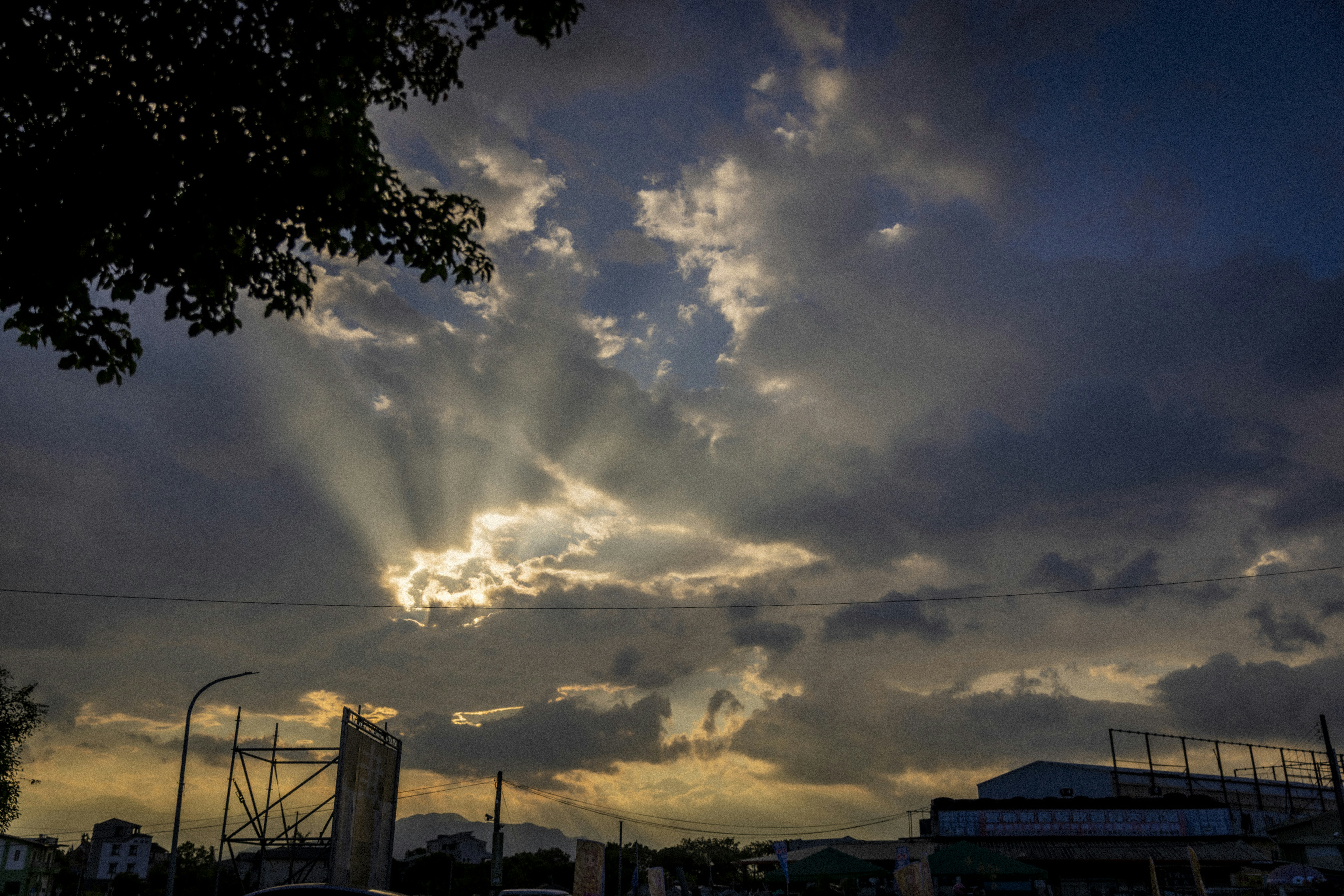 Sun rays over an urban horizon at golden hour