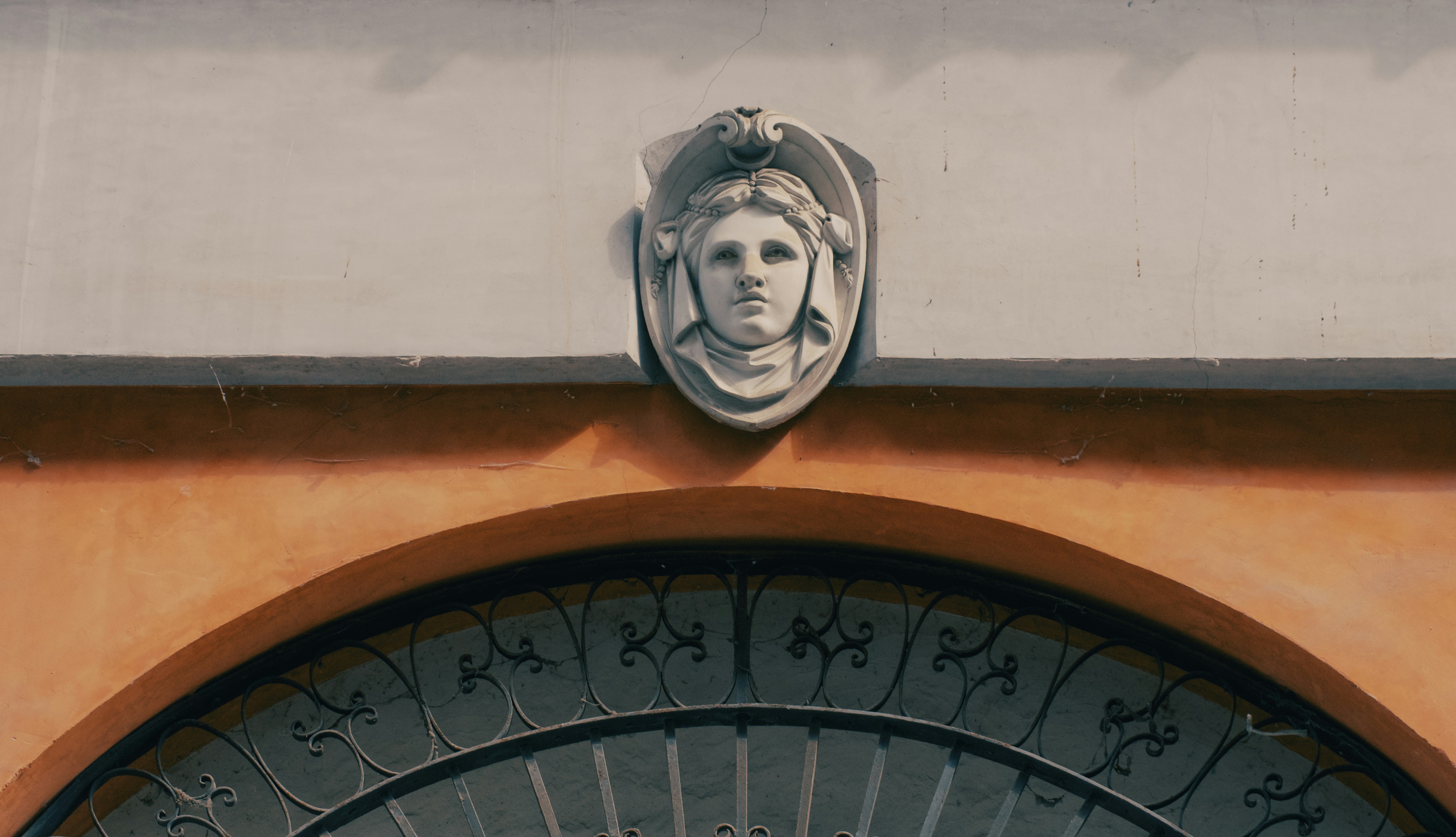 Heraldic Face Above the Orange Arch