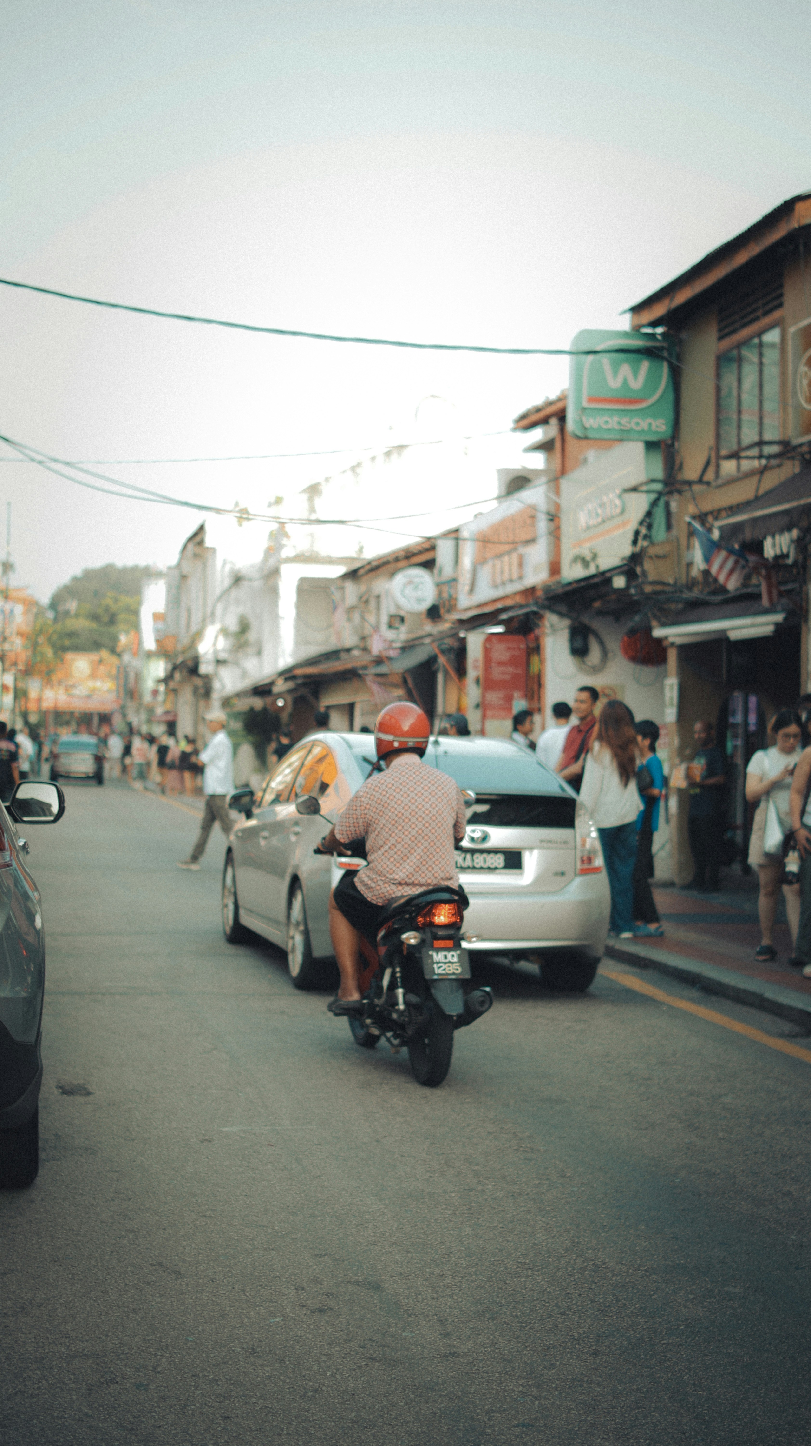Street Run: Rider in a Sunset Corridor of Shops
