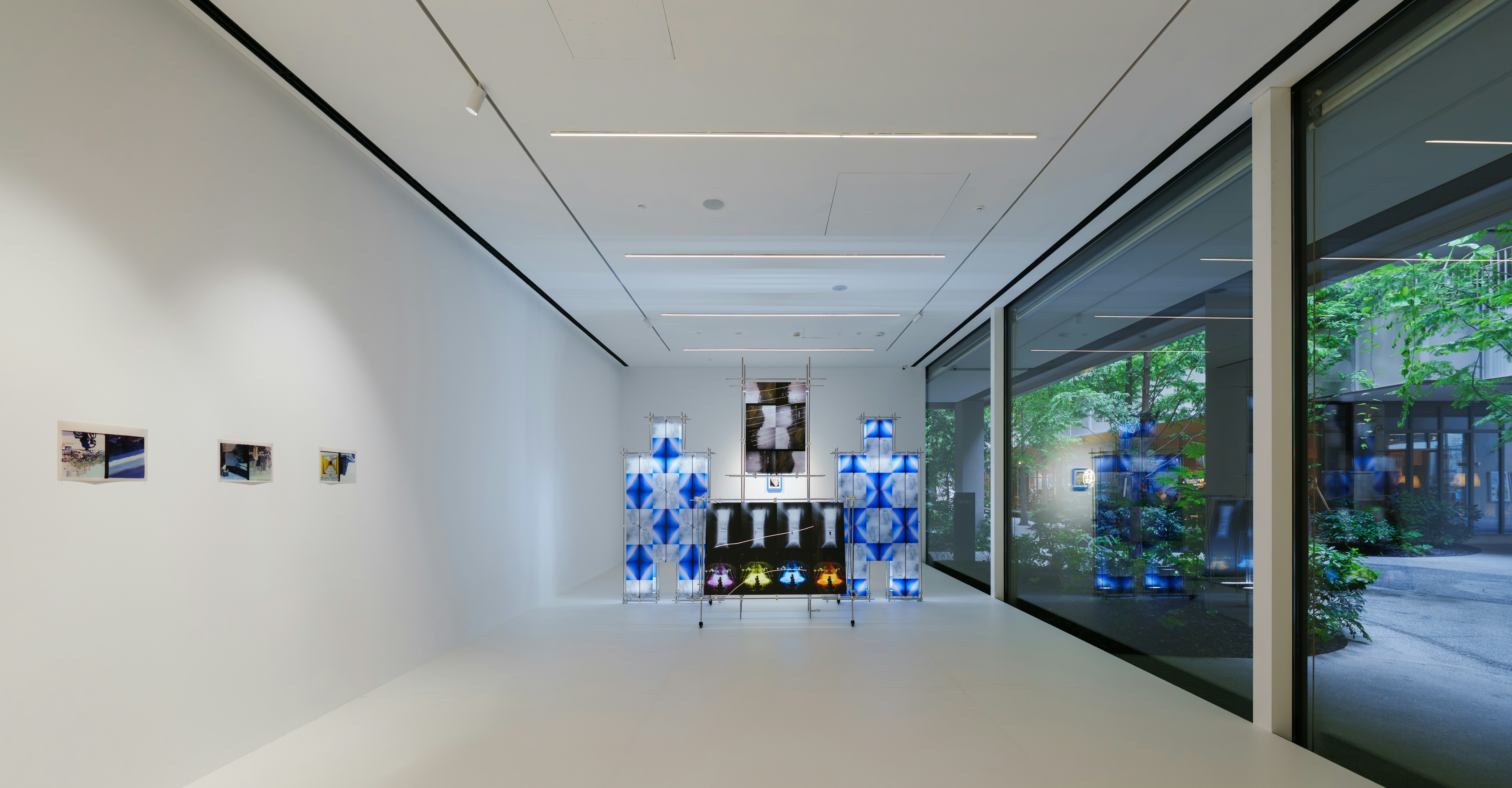 Blue Ceramic Vessels in a Sunlit Gallery Corridor