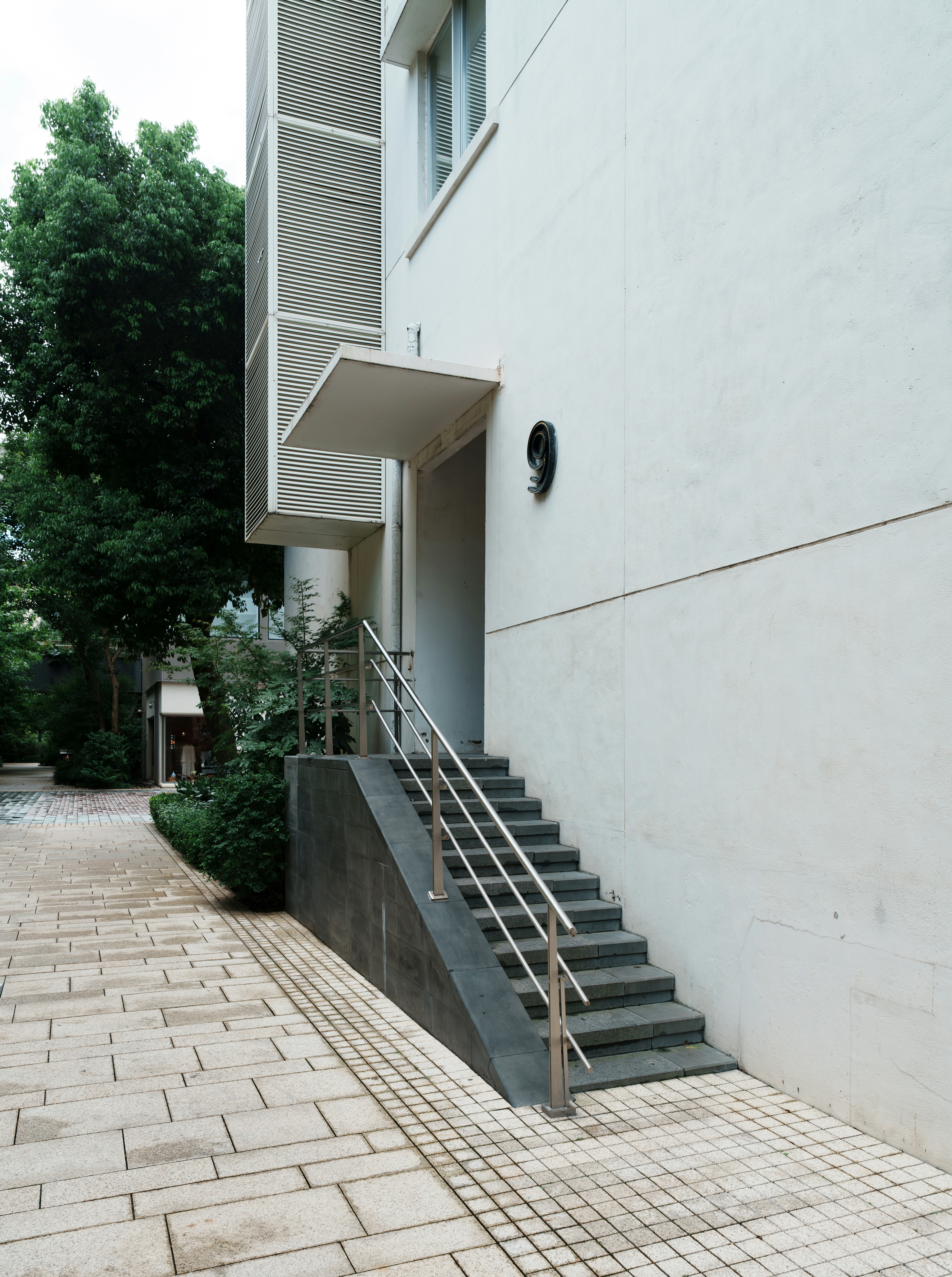 Staircase to a Quiet Entrance on a Modern White Facade