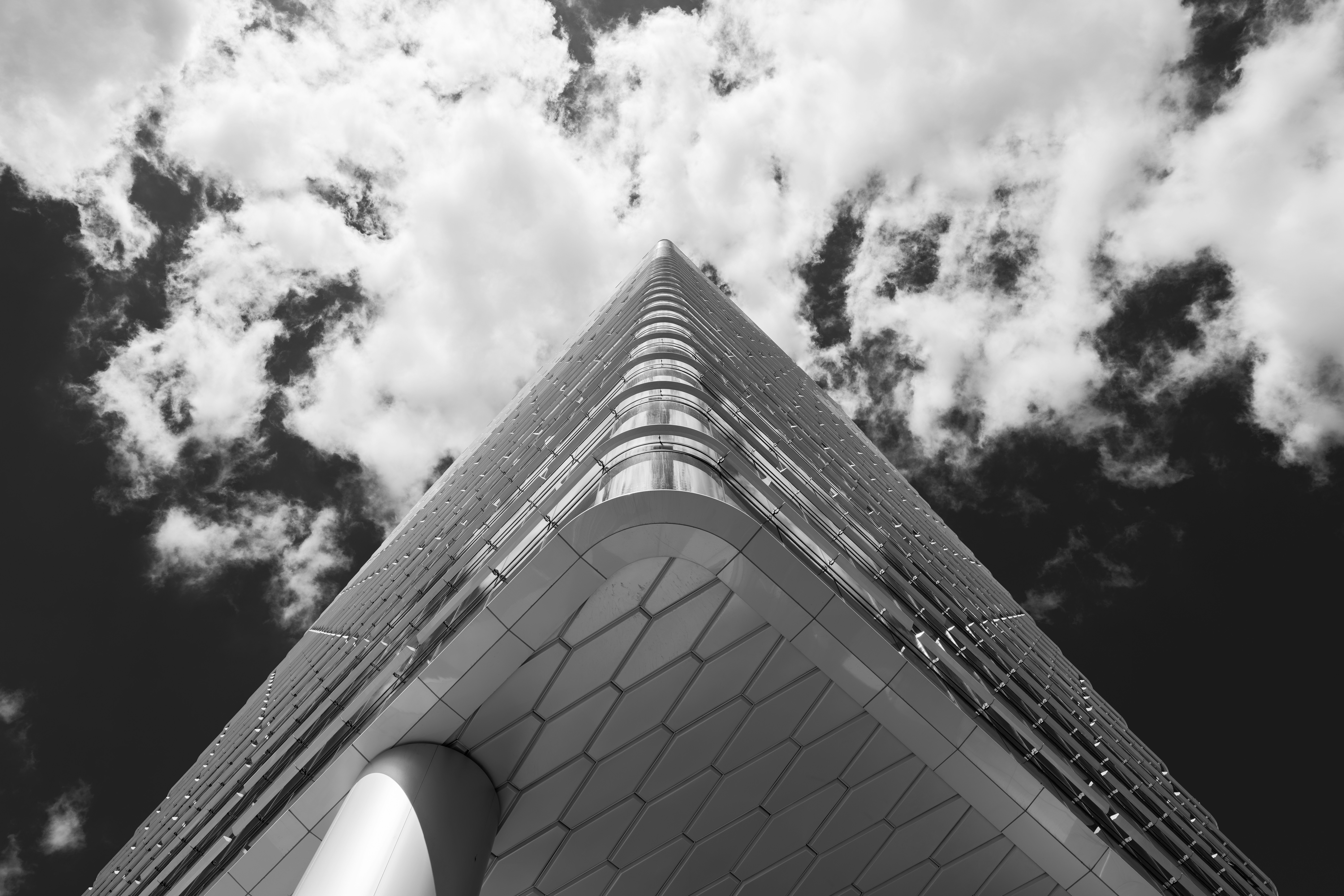 Skyward Geometry: A Tower Reaches for Clouded Skies