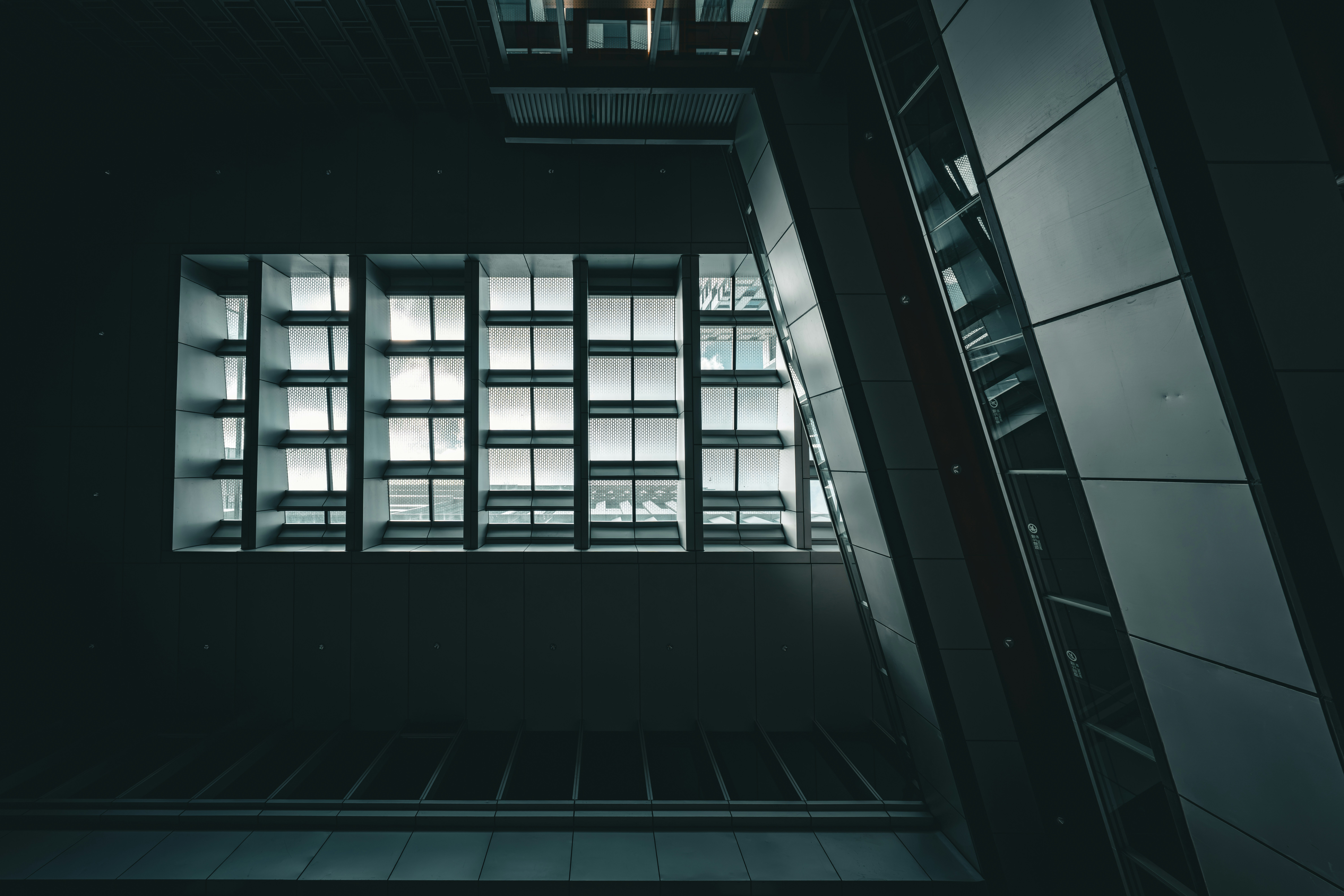 Vertical Atrium Echoes: Geometric Light Through Architectural Grids