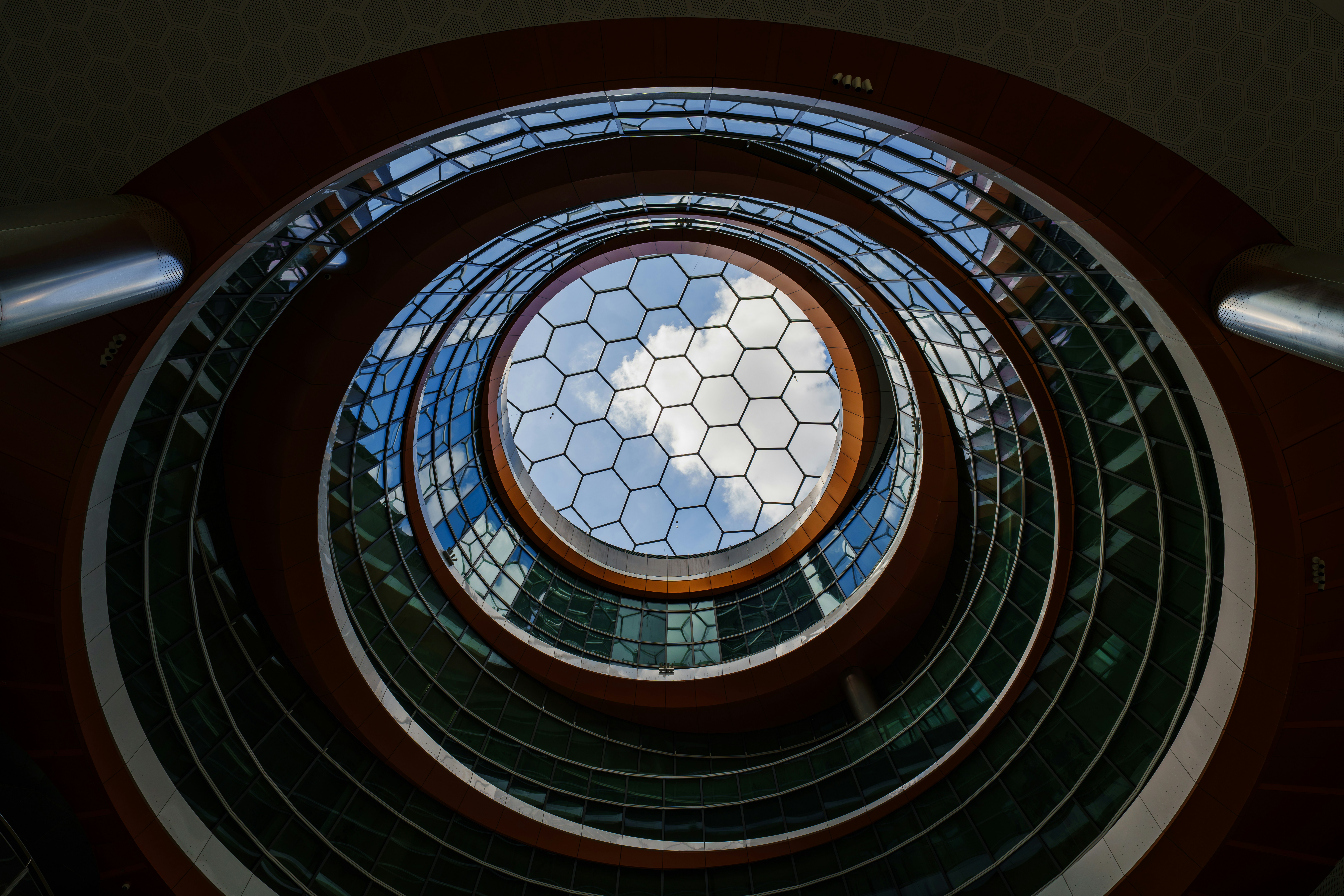 Concentric Sky: A Glass Atrium Spiral Drawn to the Light