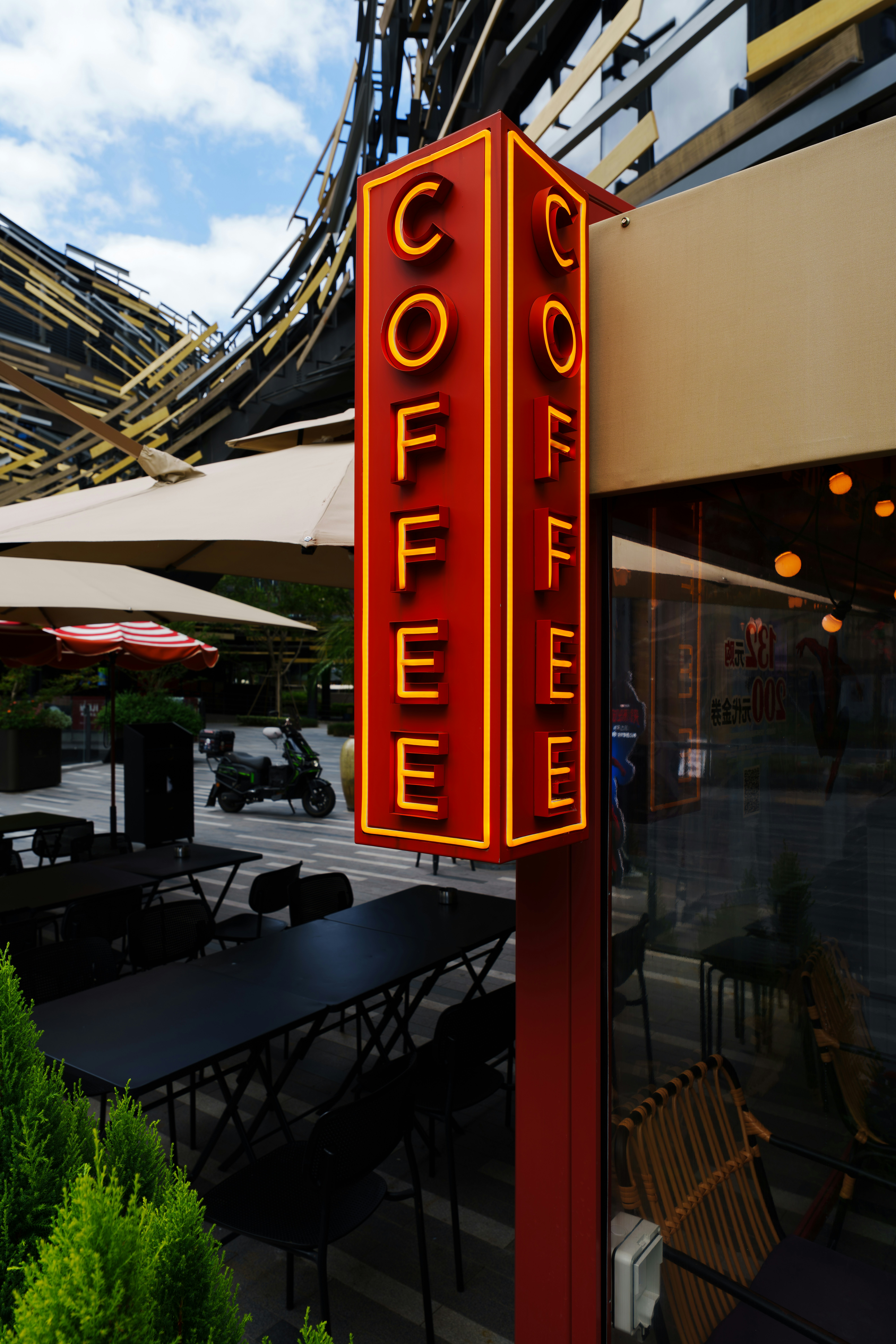 Neon Coffee Emblem: A Vertical Signway by the Street