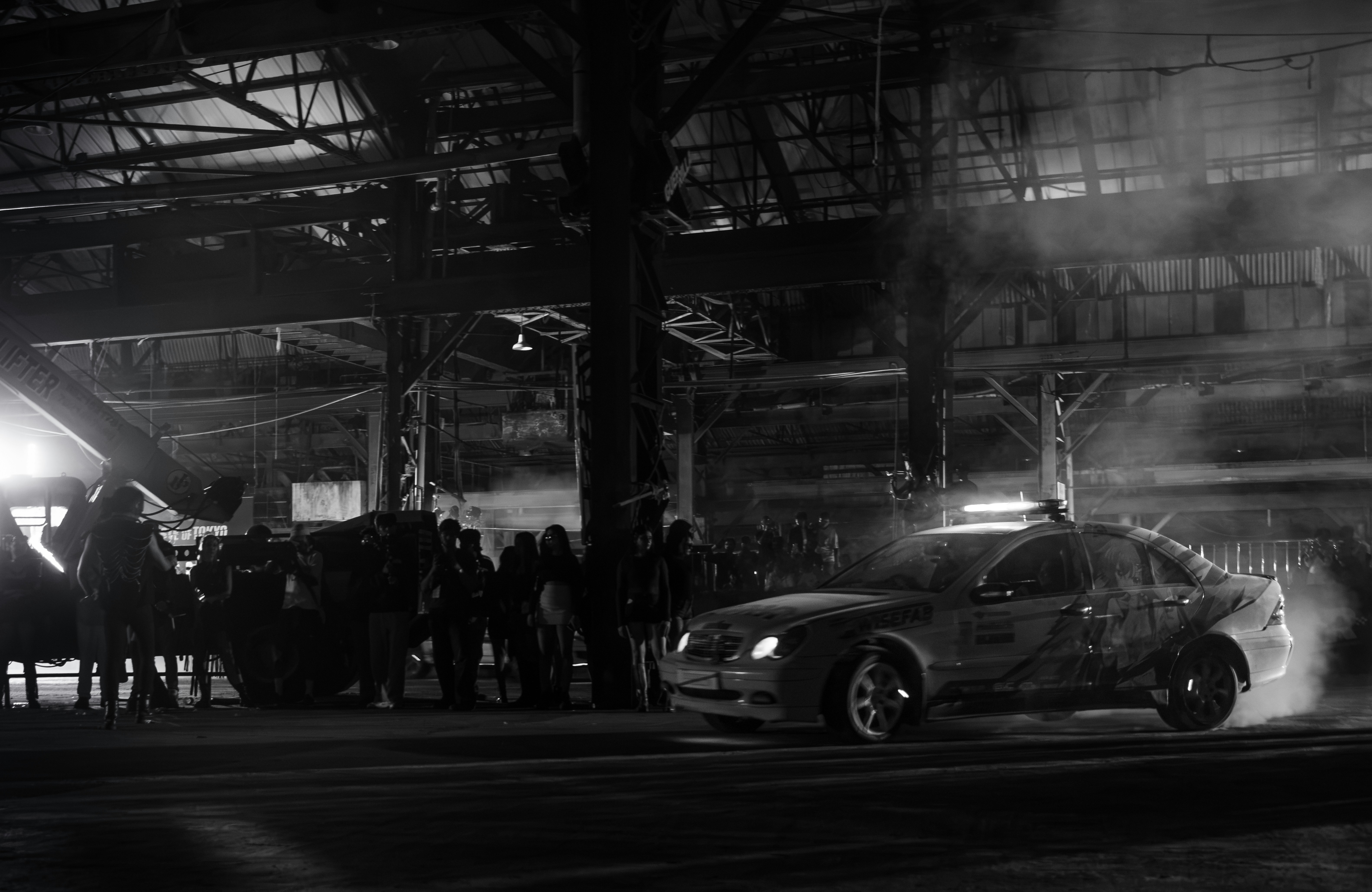 Midnight Drift: A Crowd, A Car, and Smoke in a Silent Warehouse