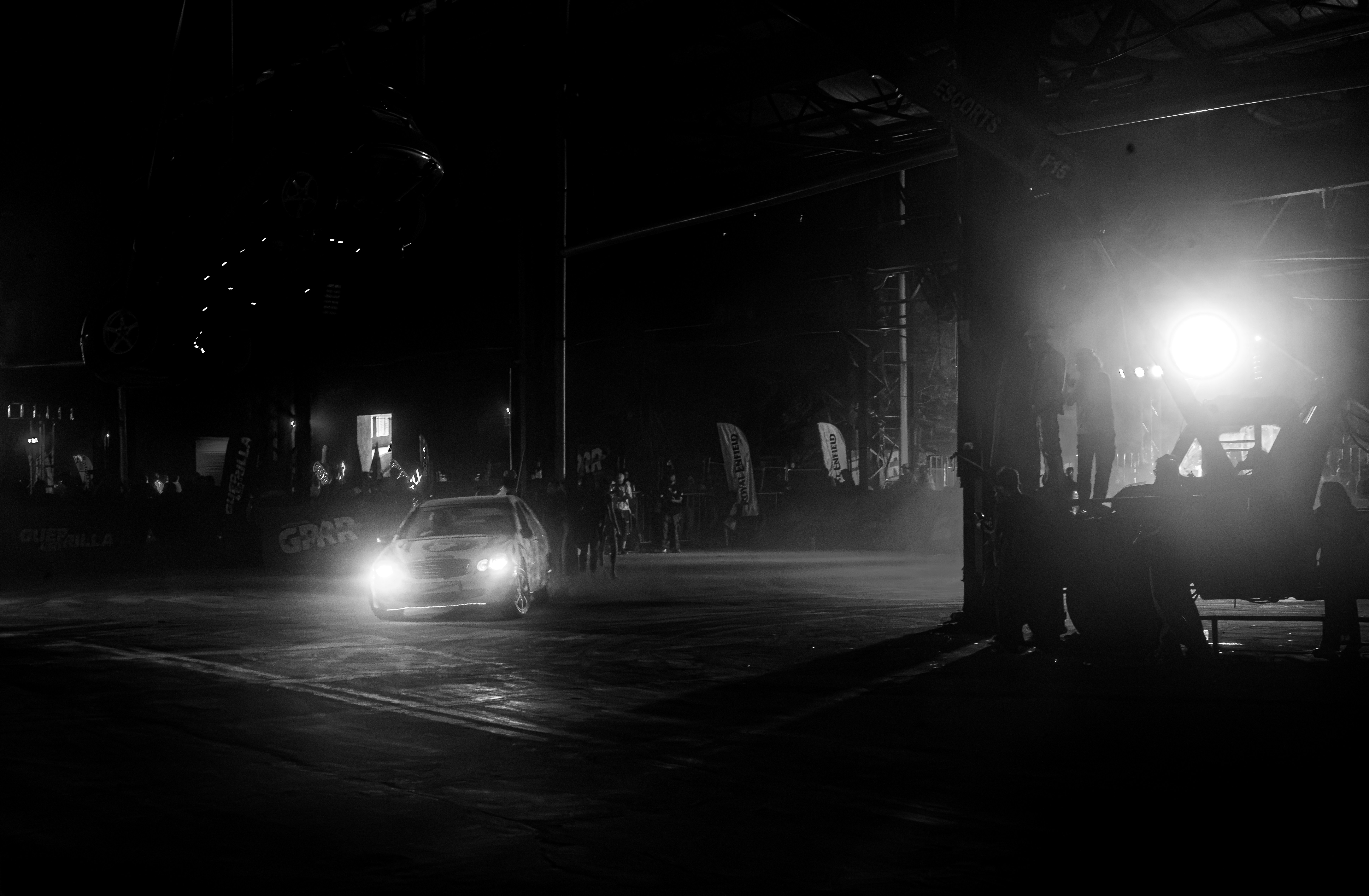 Headlights and Smoke: Night Street Drift Through the Industrial Gate