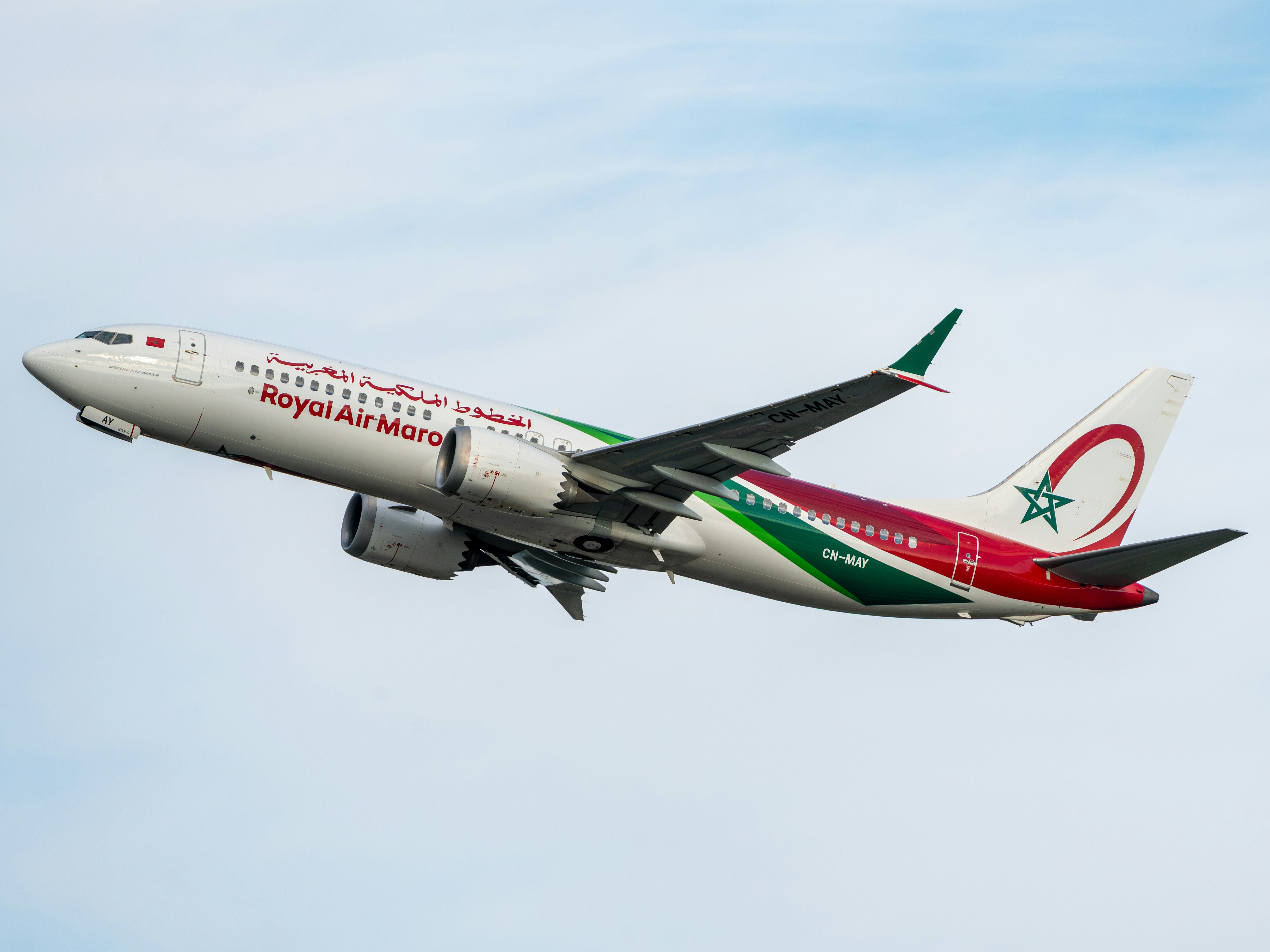Jet in blue: Royal Air Maroc climbs against a pale sky