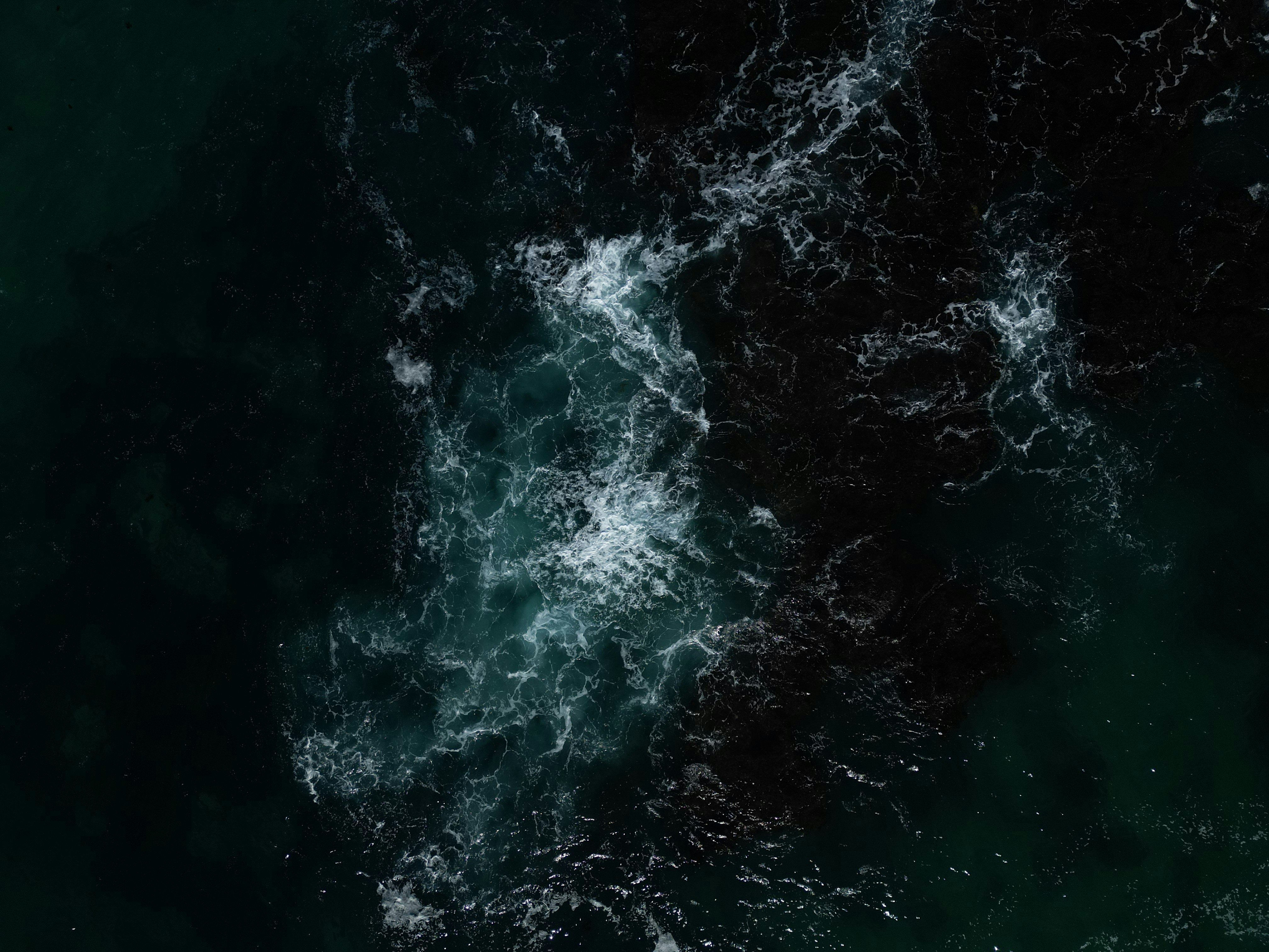 A Cresting Veil: Turquoise Currents Rushing Into Darkness
