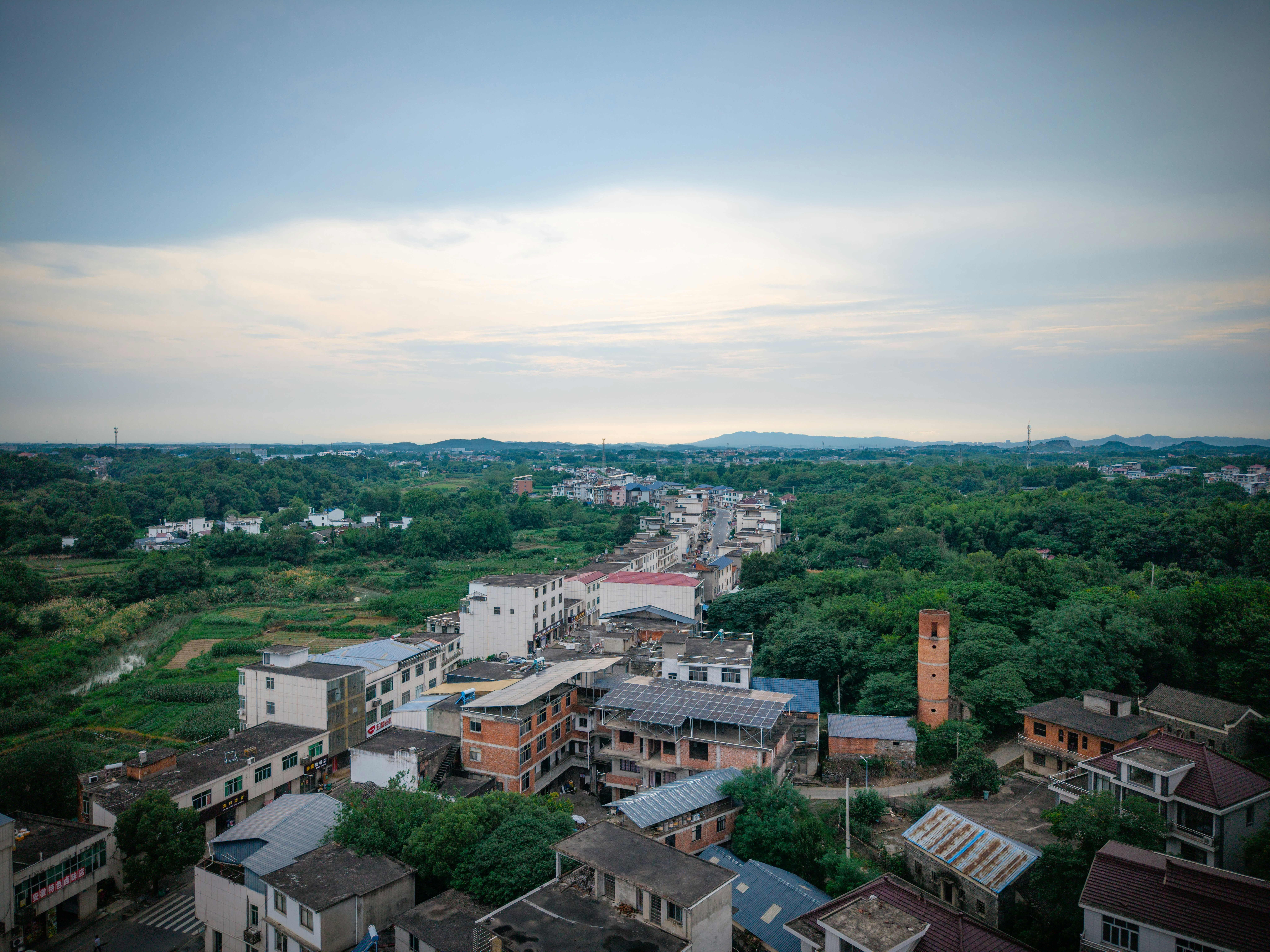 Aerial Terrace: Village Rooflines Unfold Beneath a Quiet Horizon