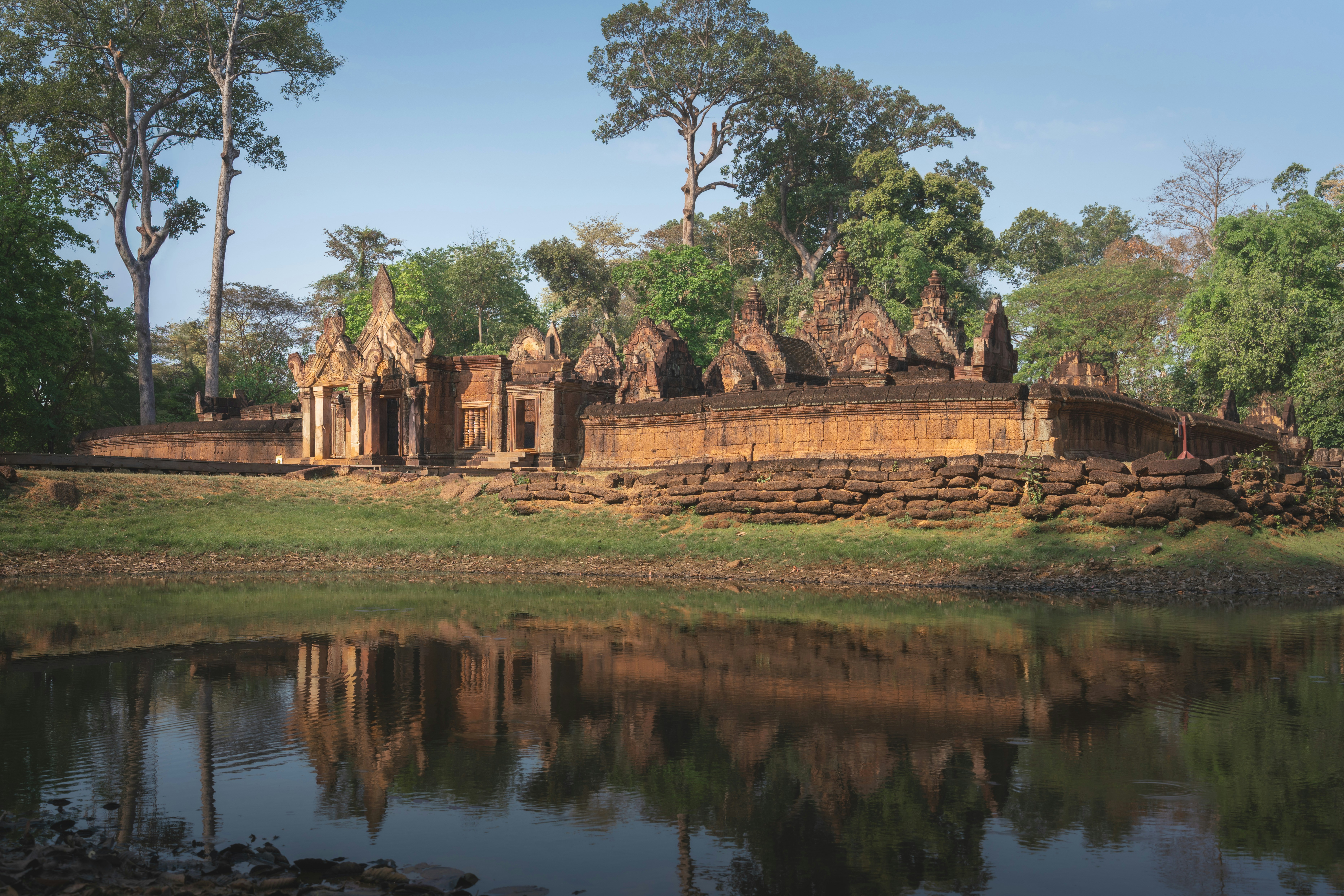 Stone Temple Echoes: A Riverside Khmer Monastery at Dusk