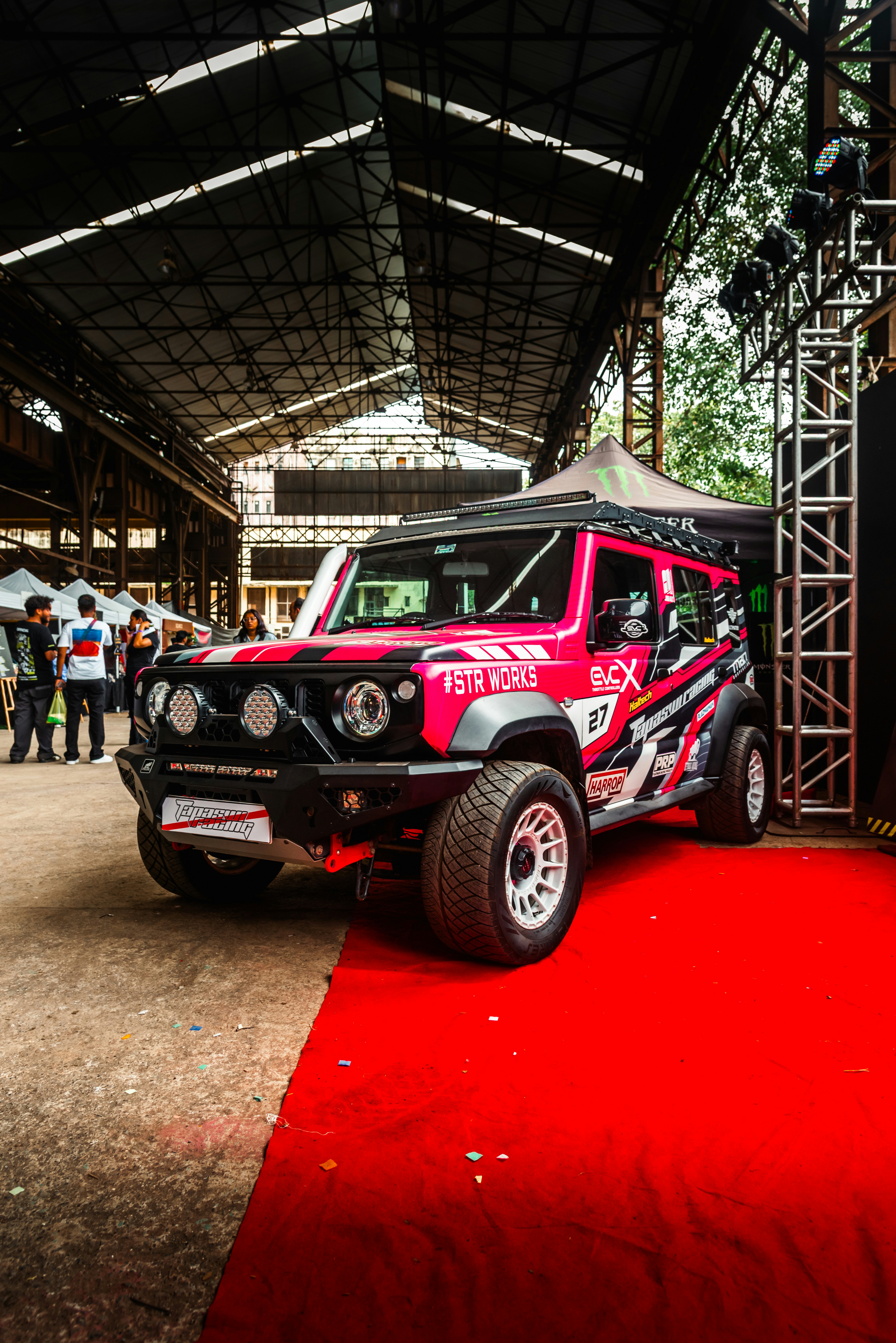 Pink Power: Rally Vehicle Struts Under the Steel Beams