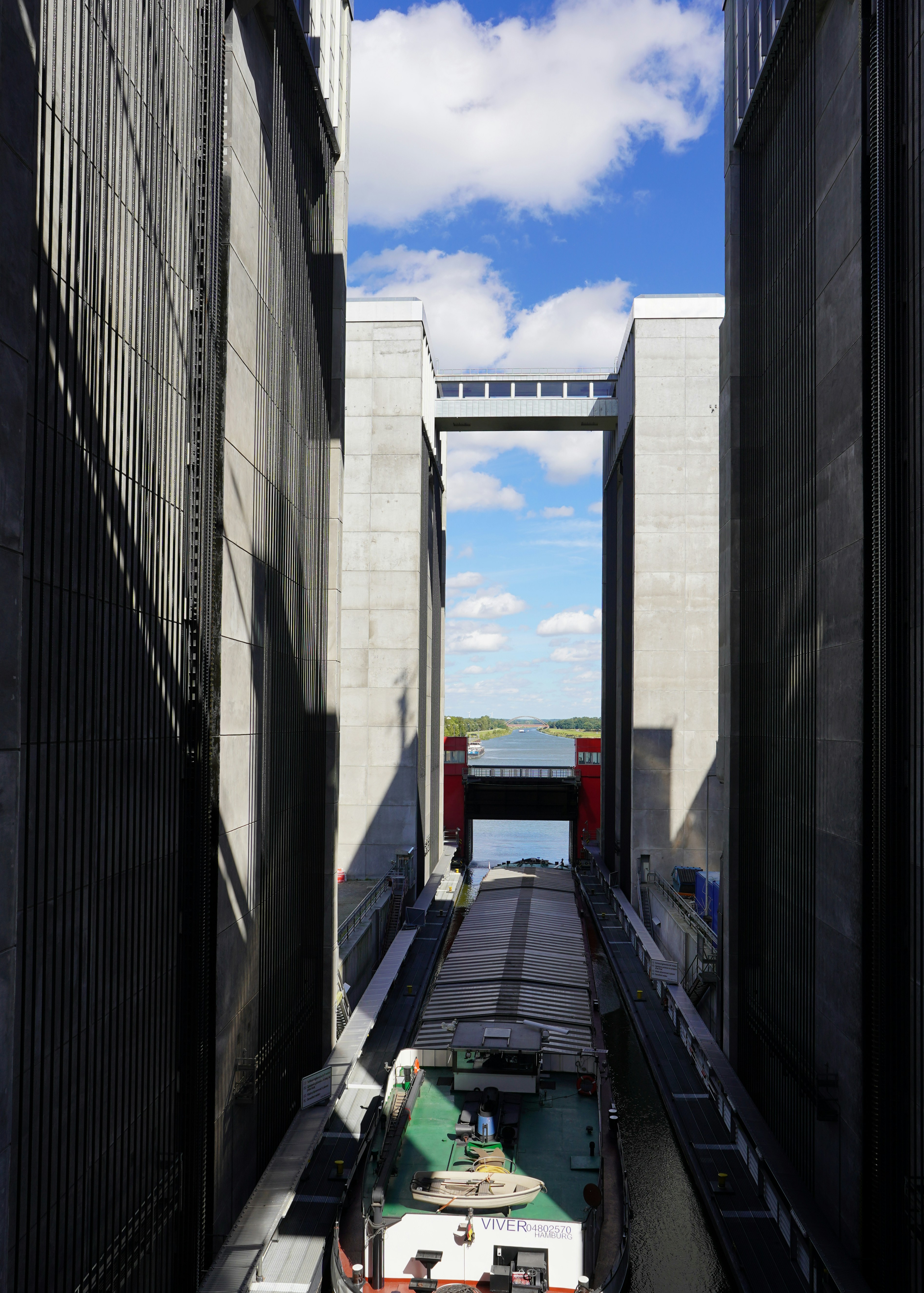 Gateway to the Waterway: Concrete Channel Framed by Skyscraper Shadows