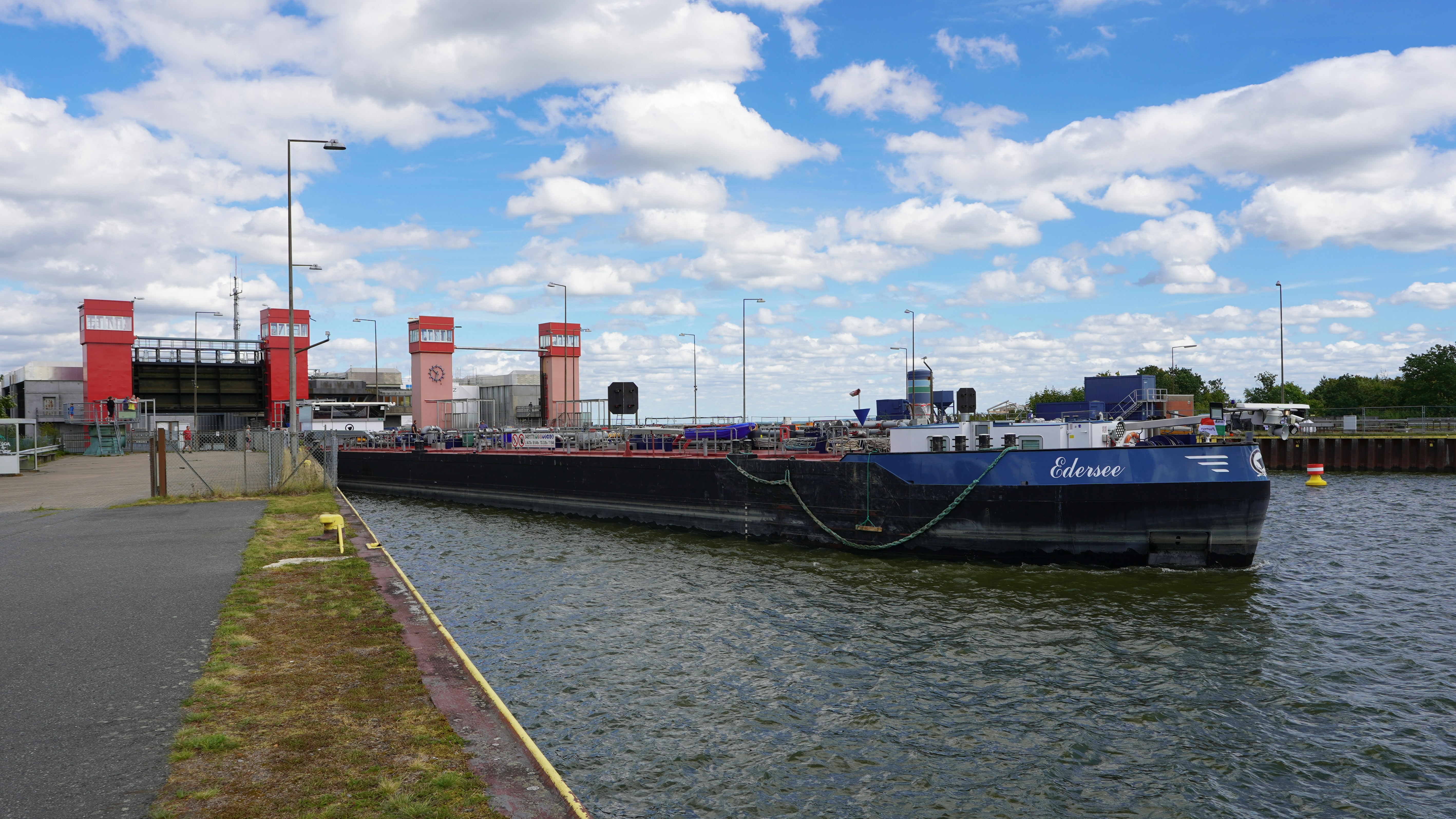Harbor Crest: A Barge Fringed by Industrial Dusk