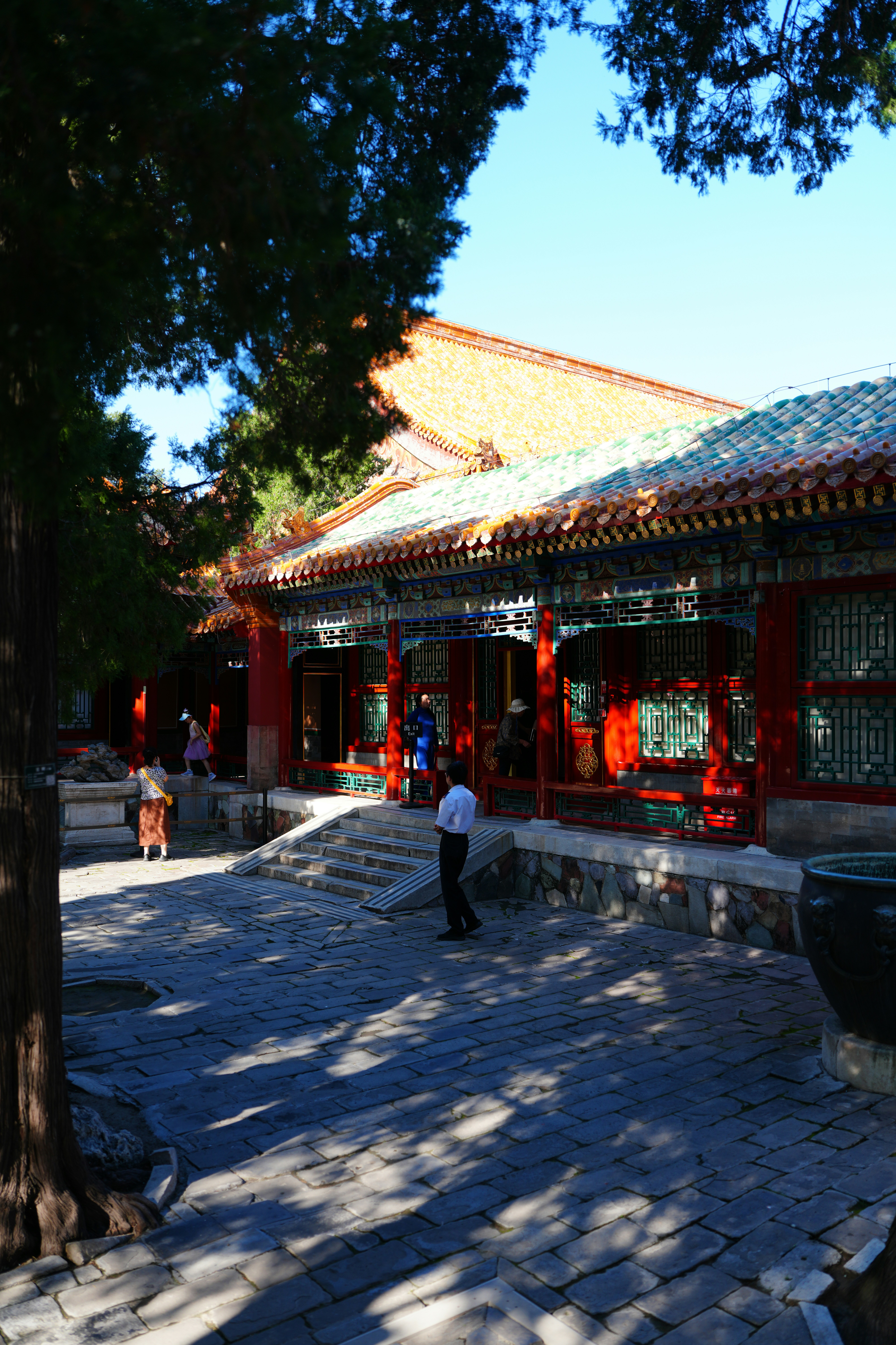 Sunlit Veranda of a Chinese Temple: Red Columns and Tranquil Courtyard
