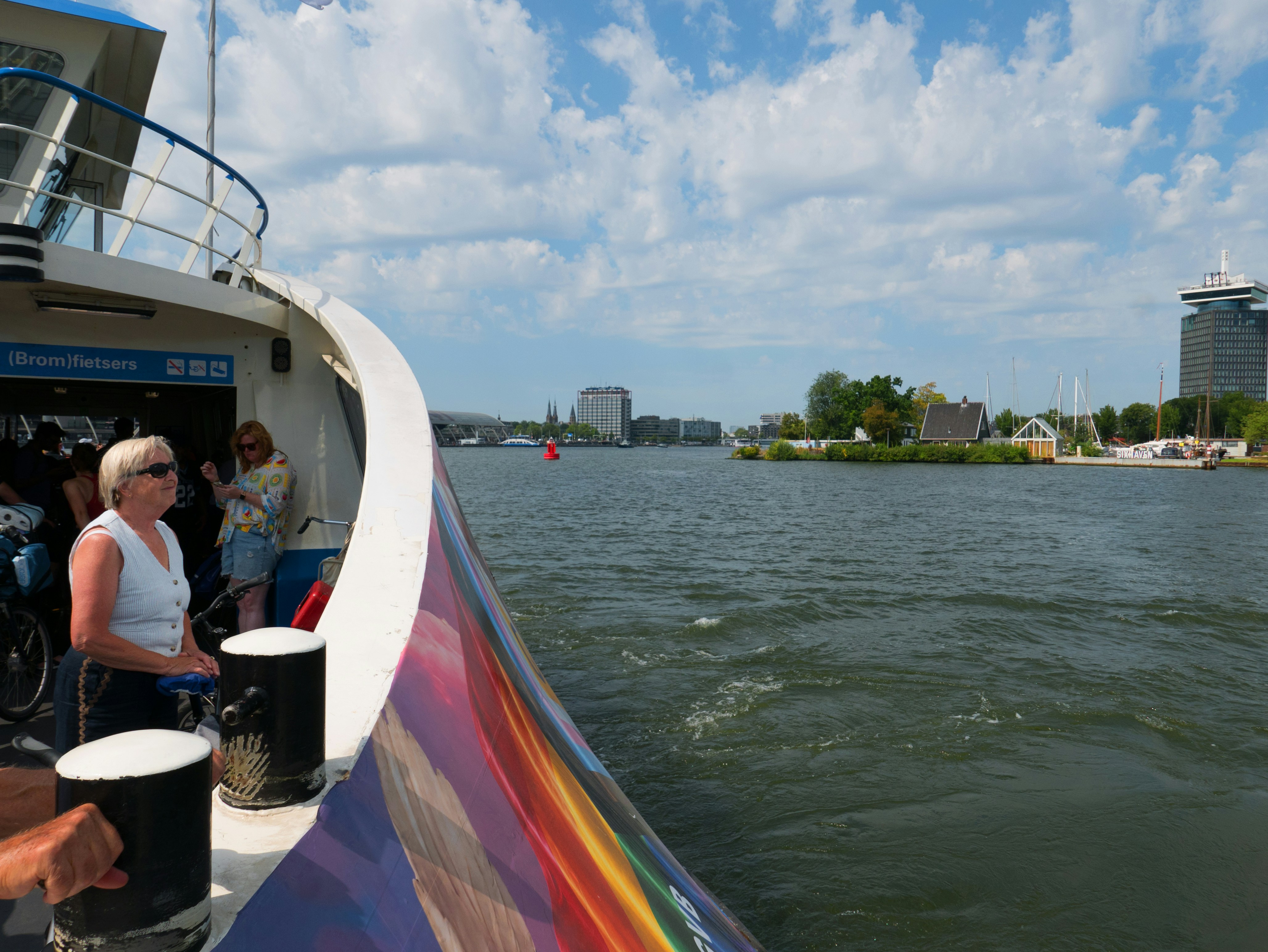Colorful Boat Edge Framing a Riverside Cityscape