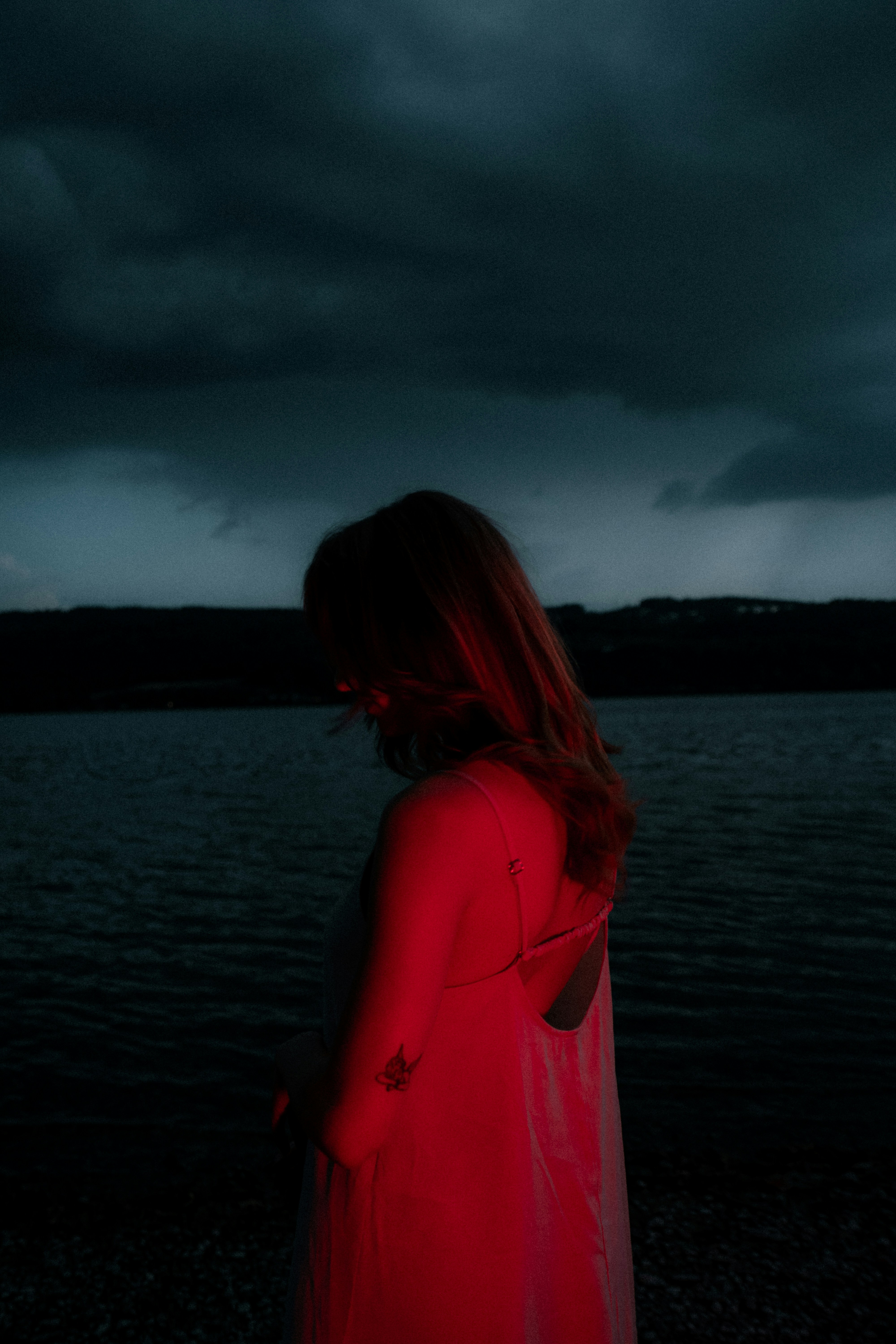 Red Veil at Dusk: A Silent Portrait by the Lake