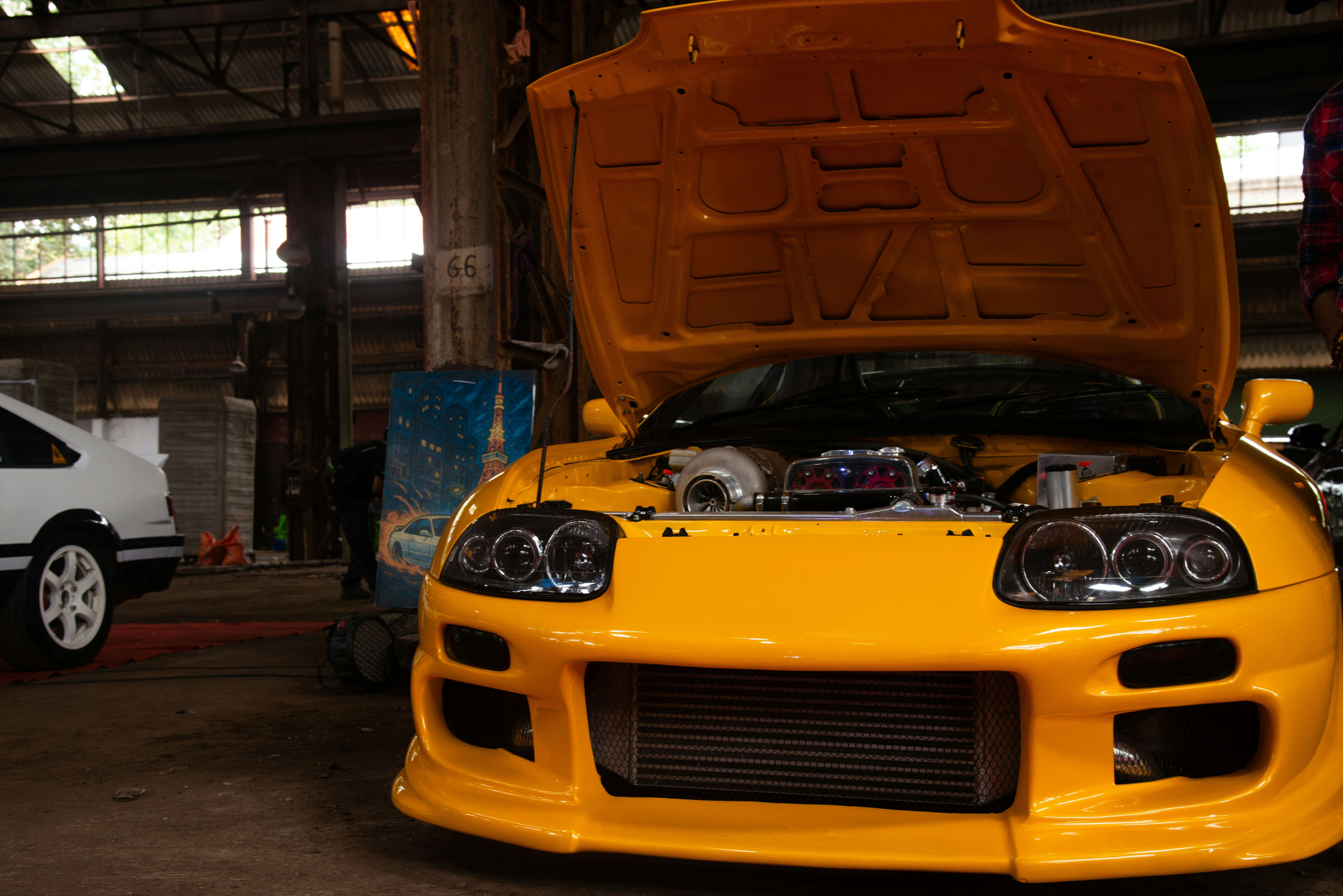 Yellow Beast Under the Hood: A Car Enthusiast’s Workshop Portrait