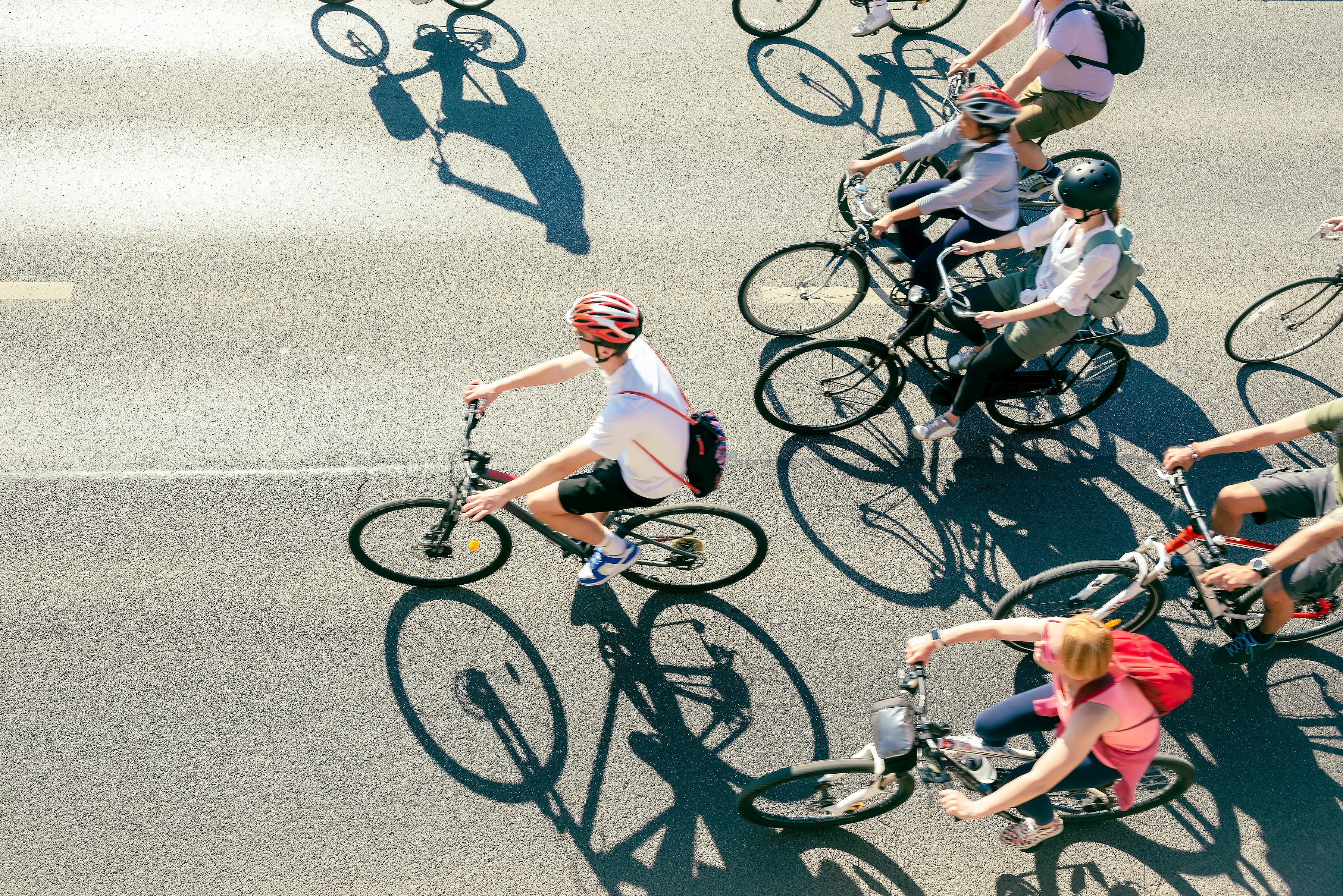 Overhead Cyclists in Motion: A City Street Parade of Color