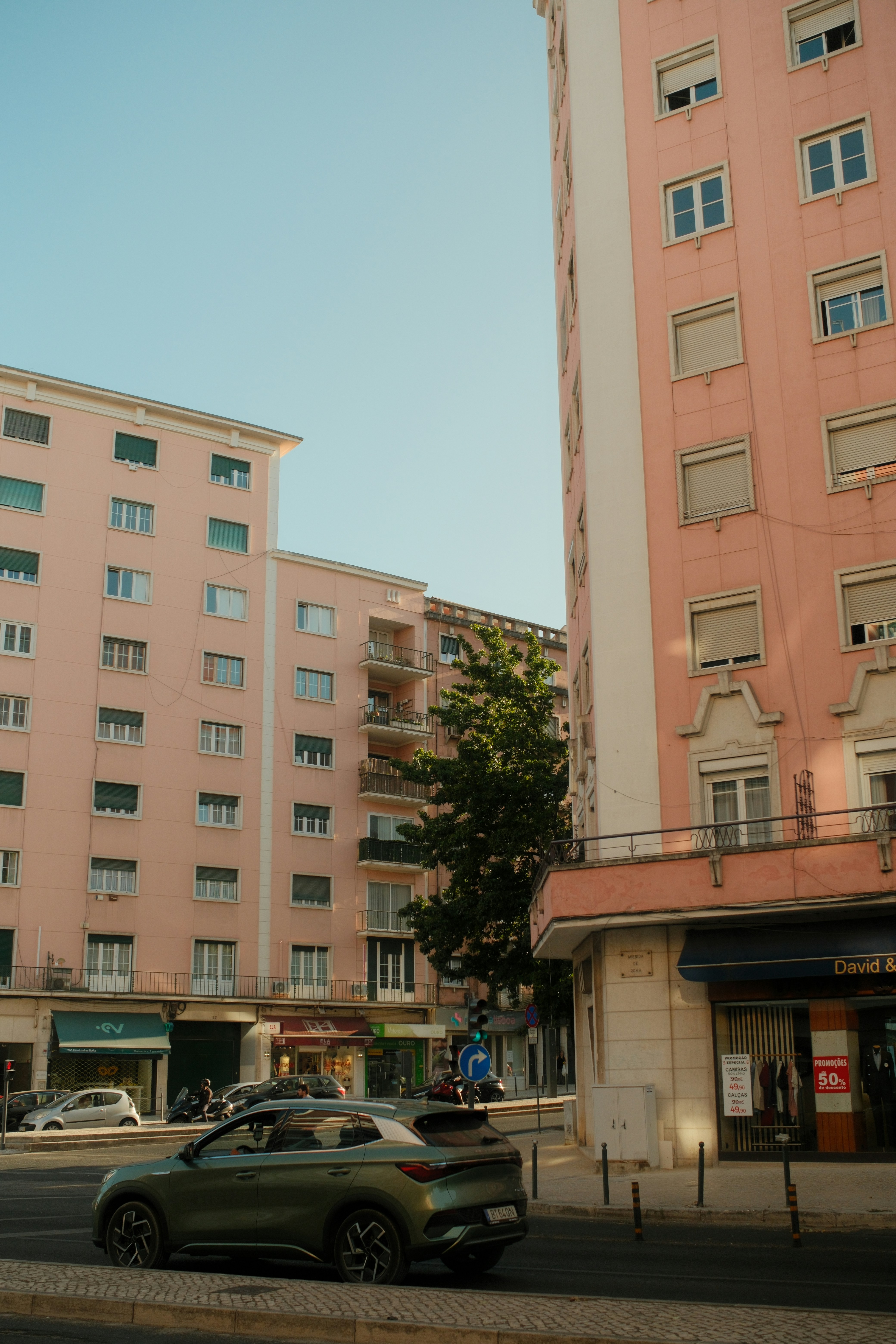 Sunlit Street Facade: Peach Buildings Framing a Quiet City Moment