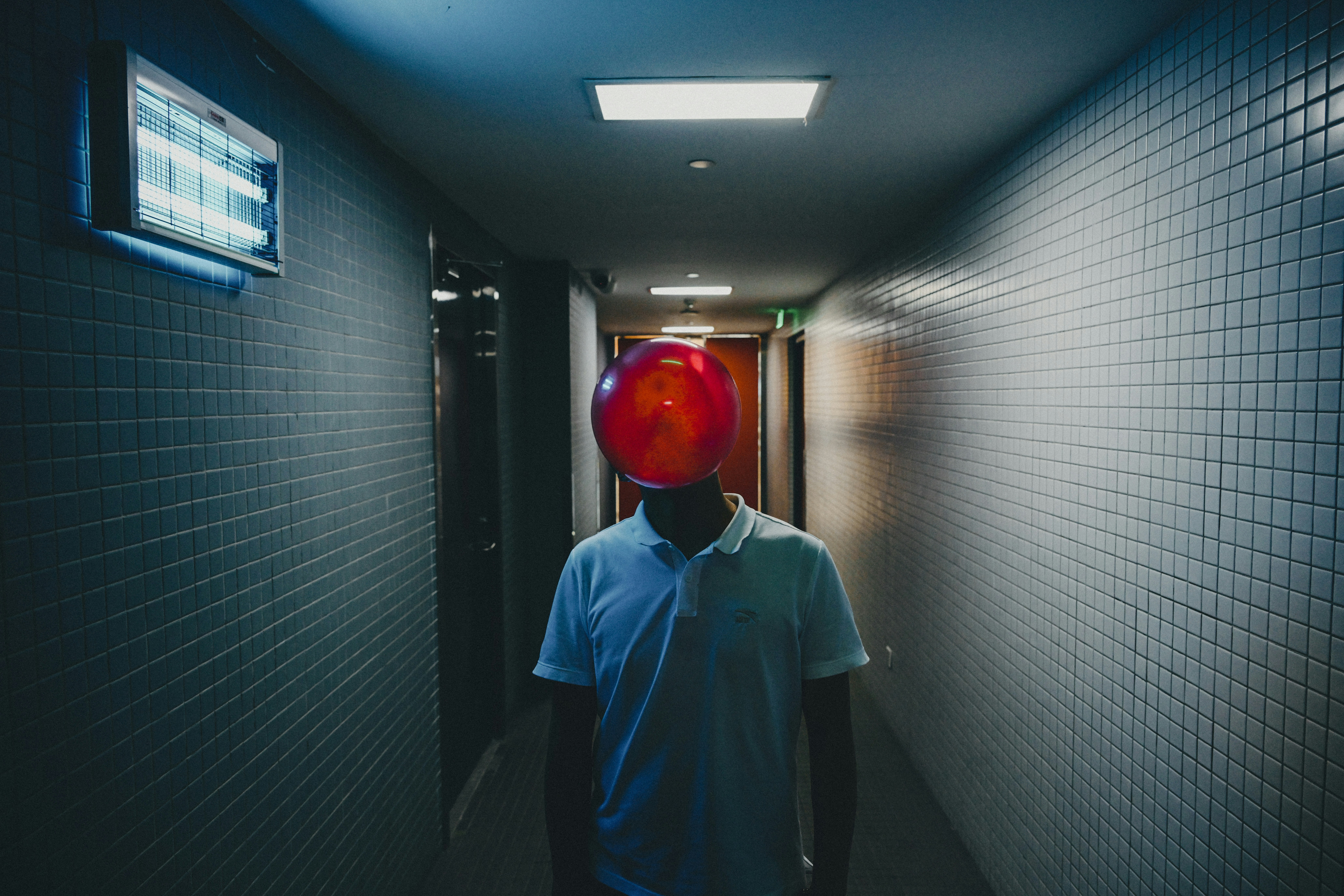 Ballooned silence: a dim hallway silhouette