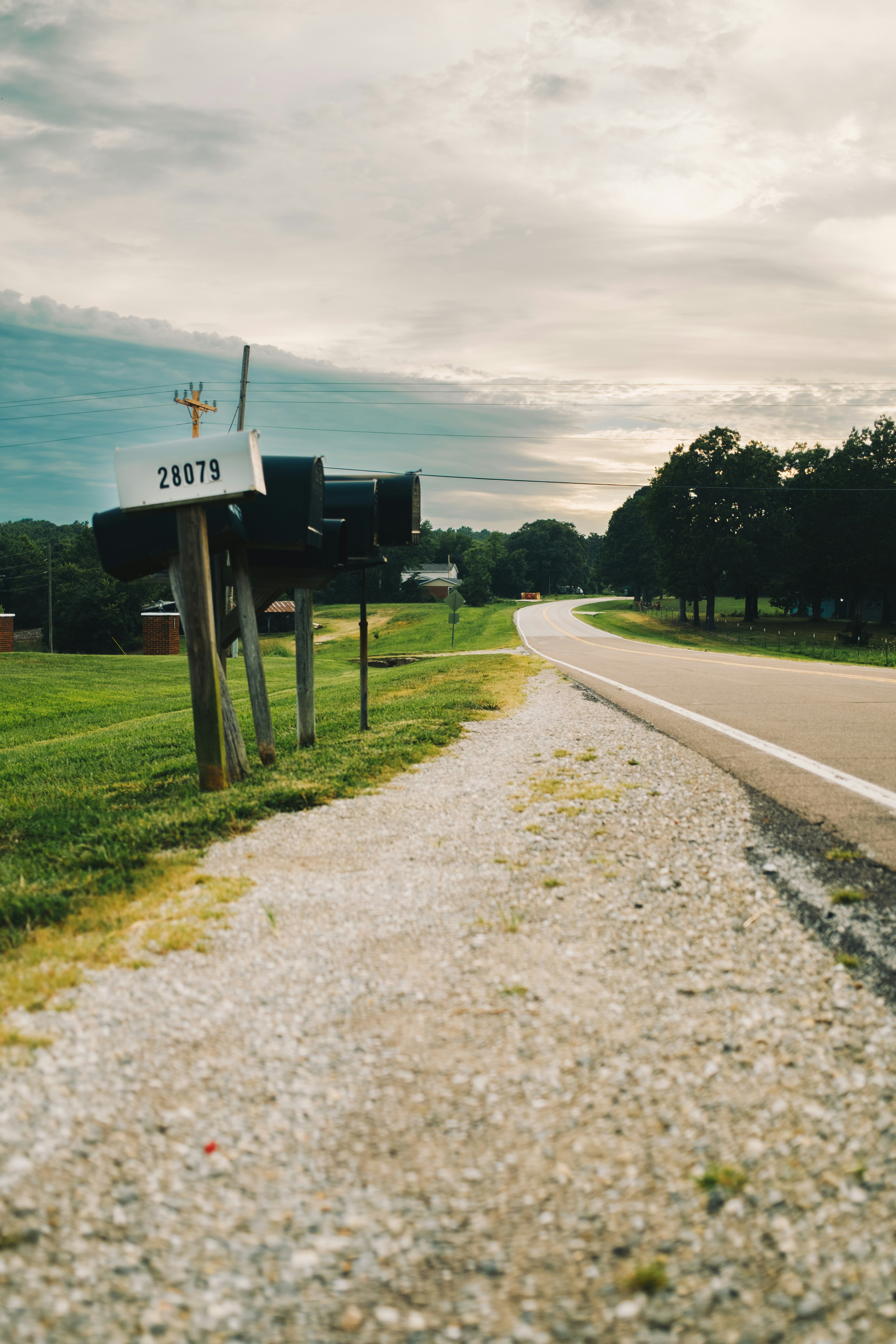 Country Road Convergence: Mailboxes Lean into the Curve