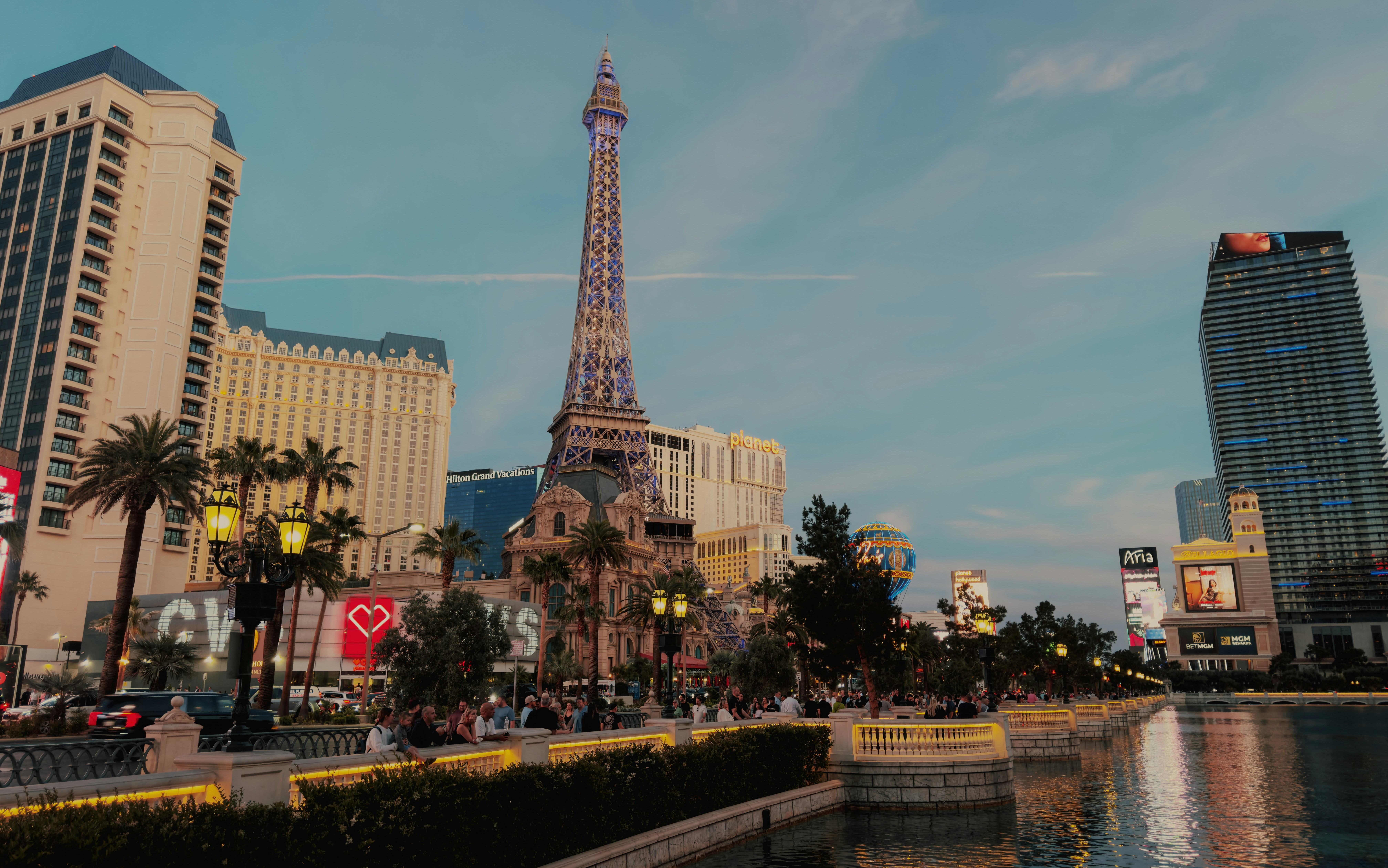Nightlife on the Strip: The Eiffel Tower Glow Over a Neon Shuffle