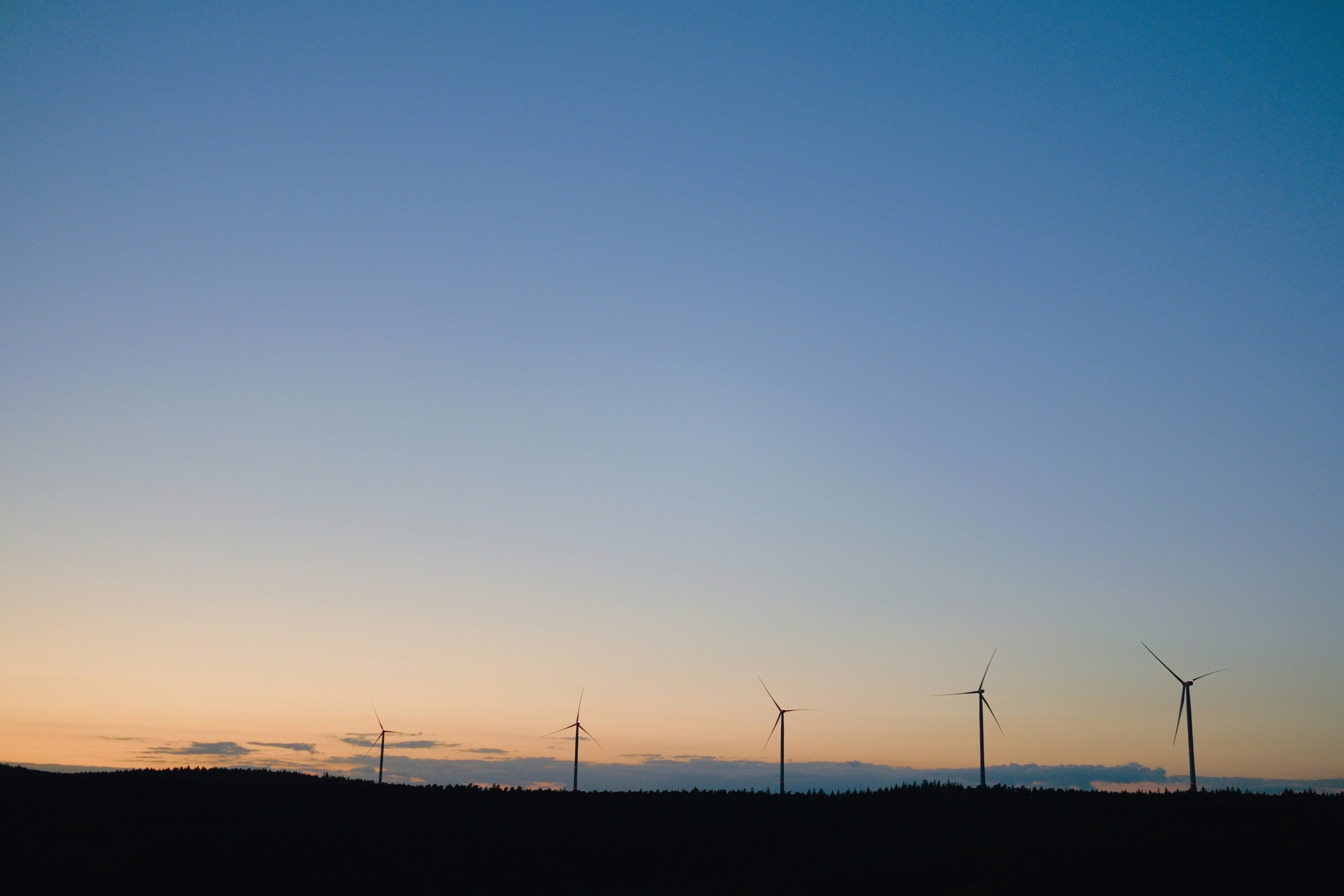Wind Farm at Dusk: Silhouettes on a Velvet Horizon
