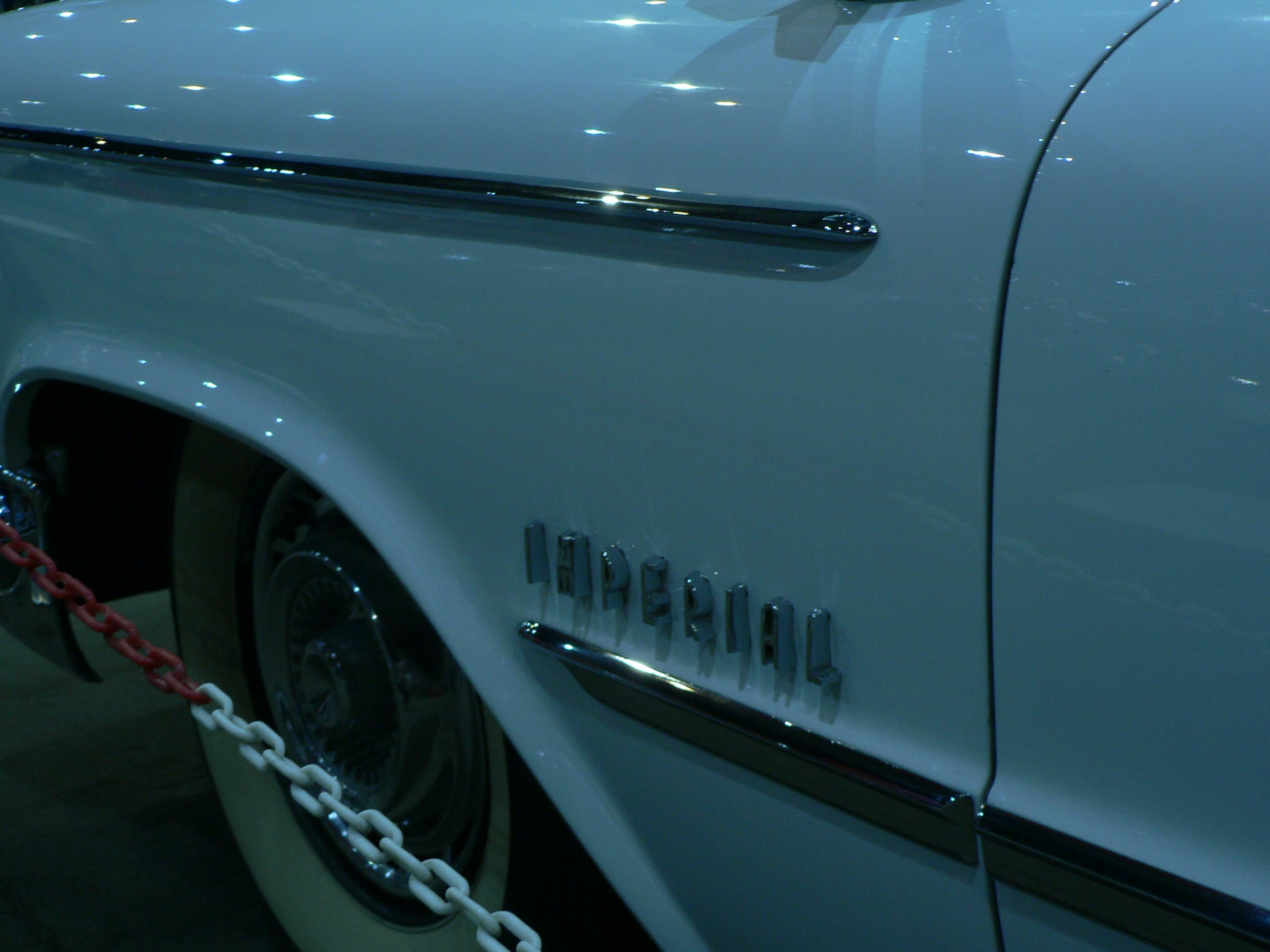 Chrome Script: The Classic Chevrolet Impala Badge Under Gallery Lighting
