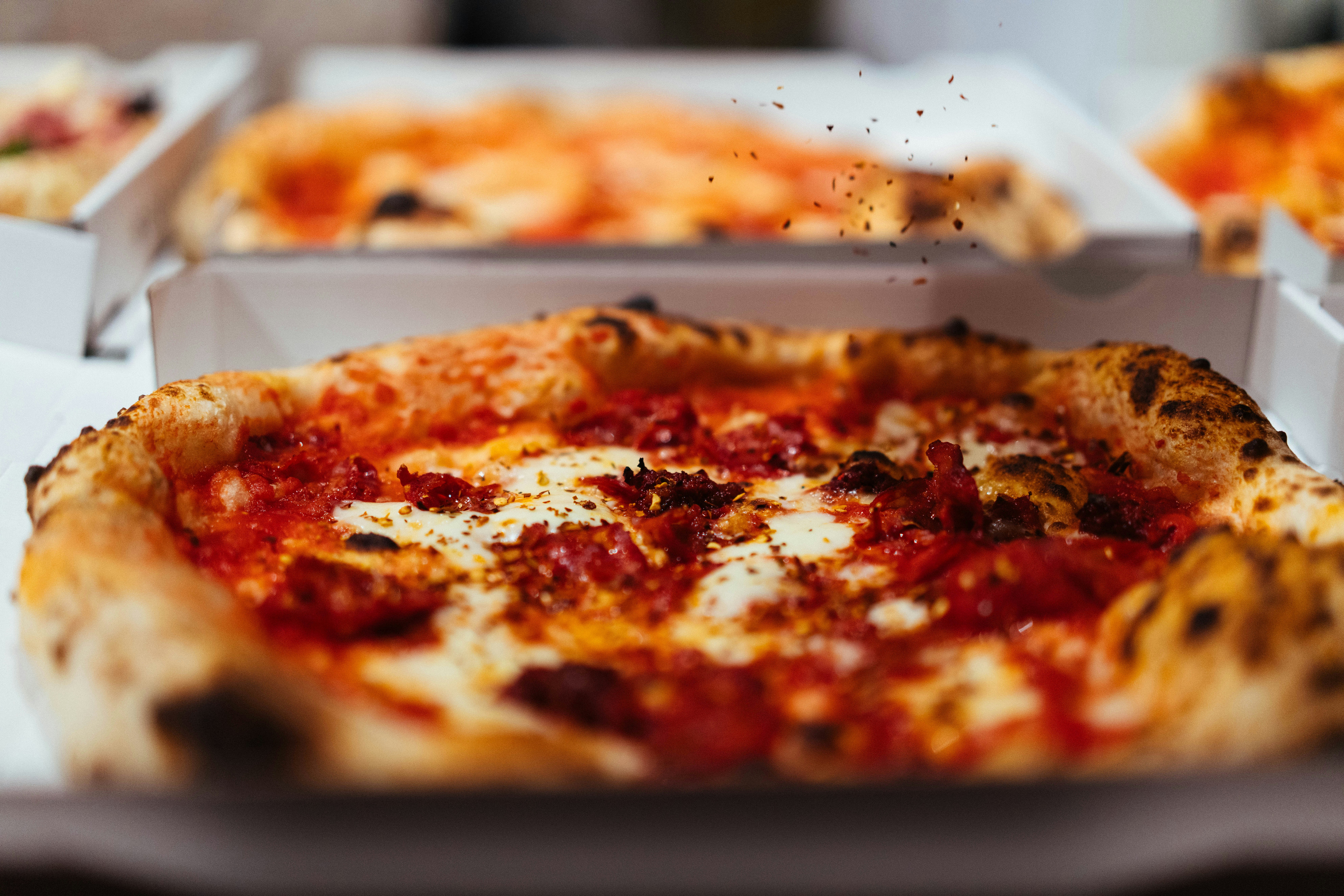 Crust Edge Glory: A Close-Up of Fire-Kissed Pepperoni Pizzas